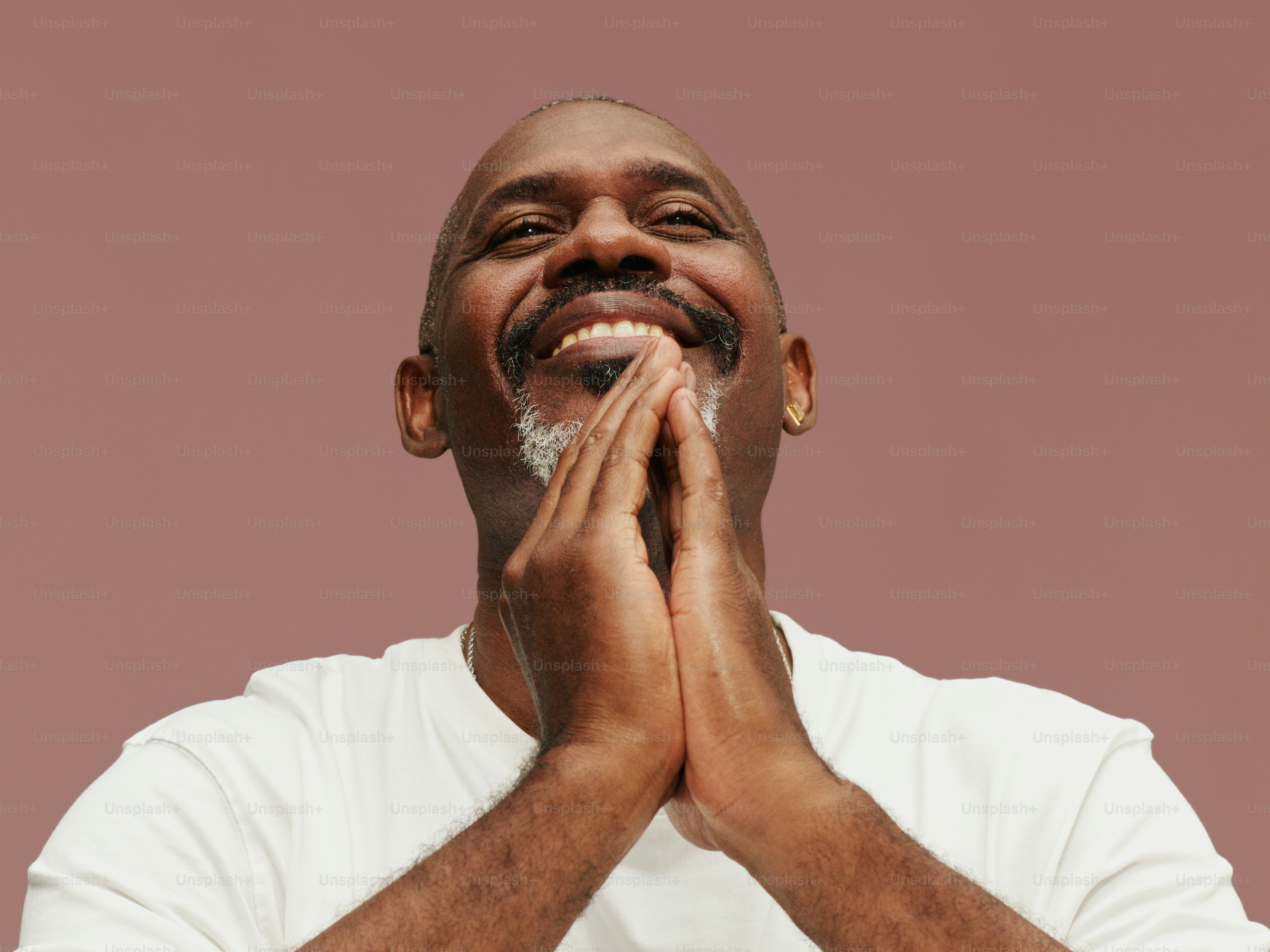 Man with hands clasped in prayer, smiling joyfully photo – Inspiration ...