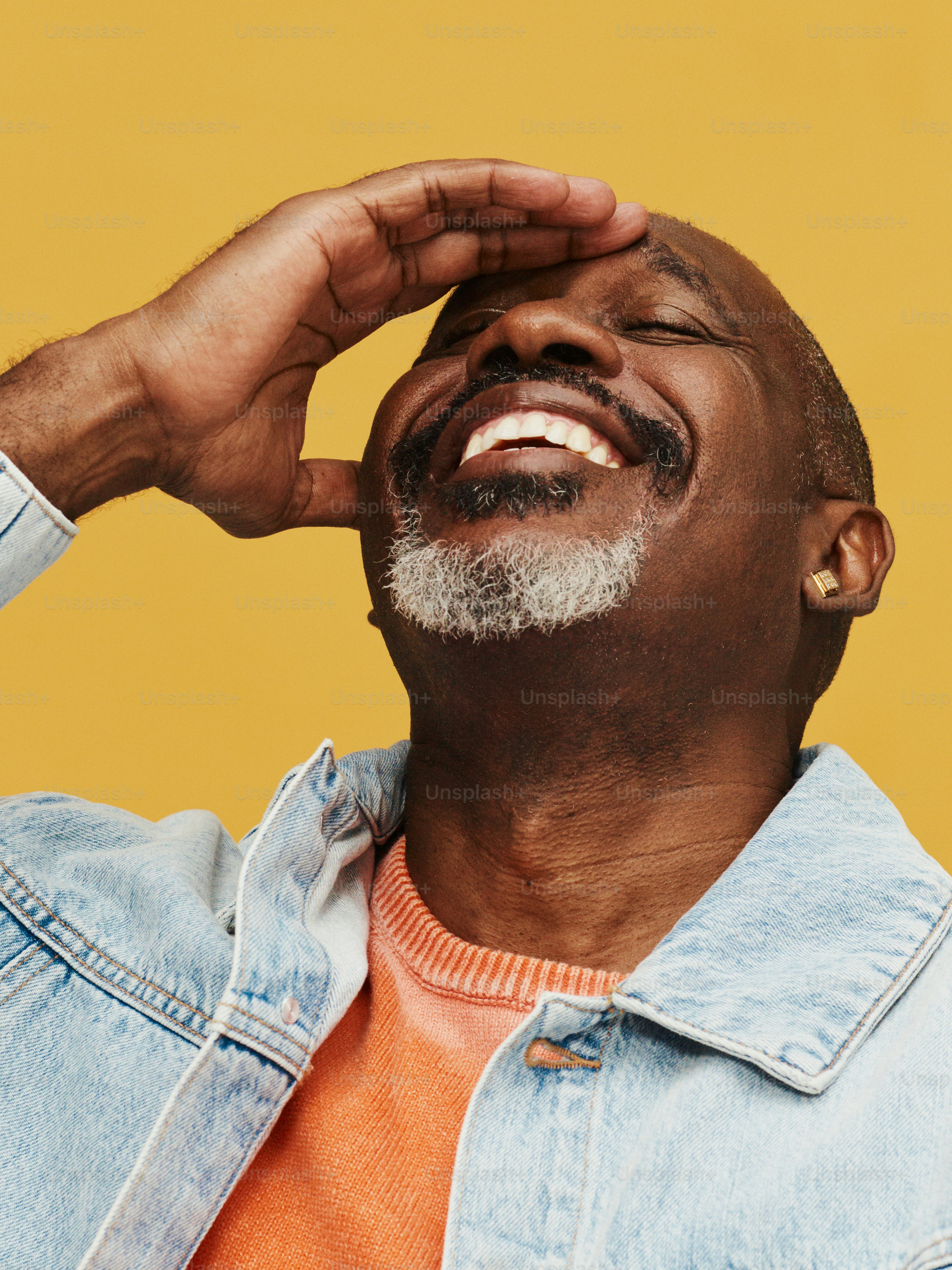 A man with a beard laughs with hand on forehead. photo – Face Image on ...