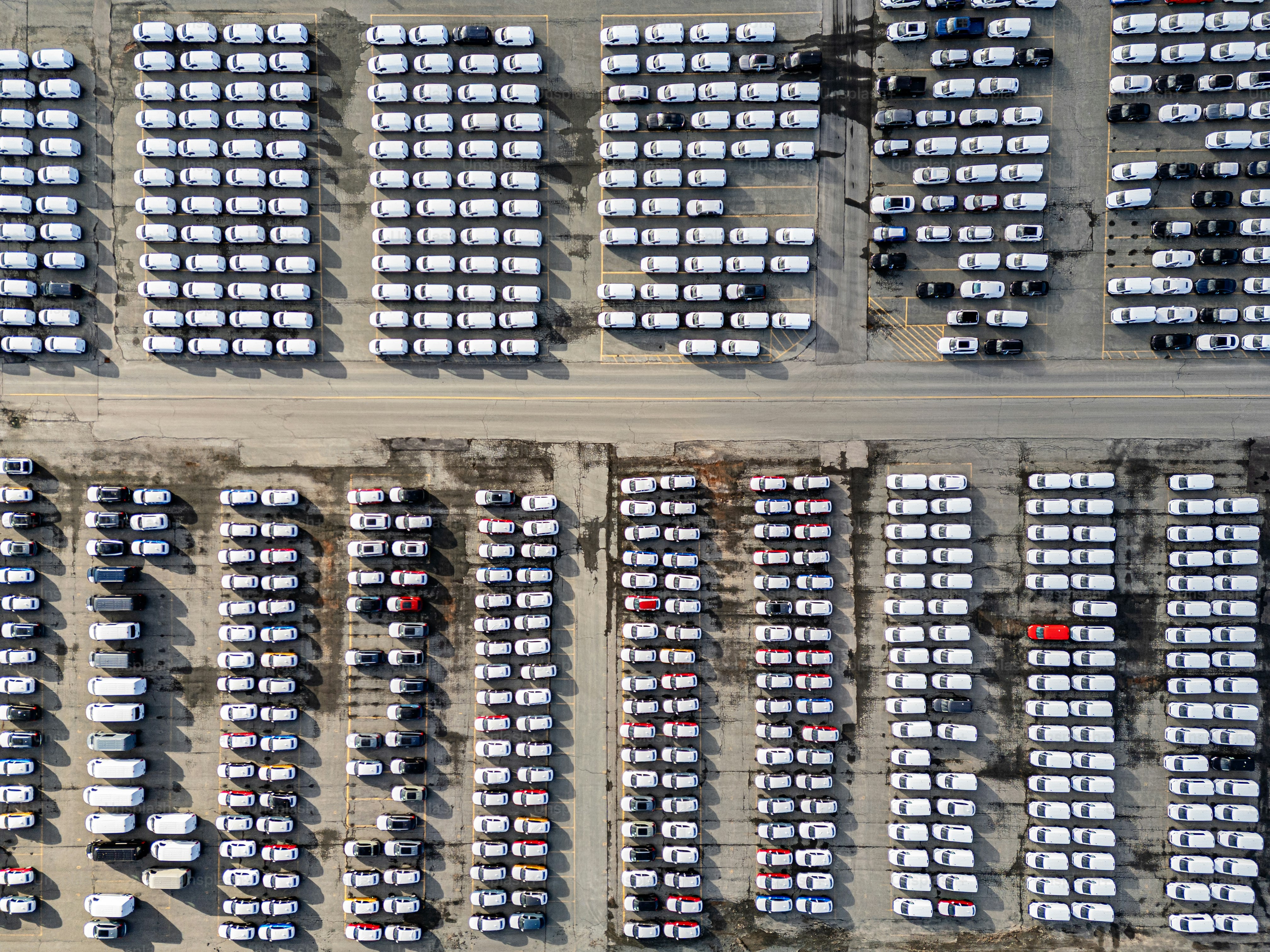 Aerial view of a large autoport where vehicles are transported by rail ...