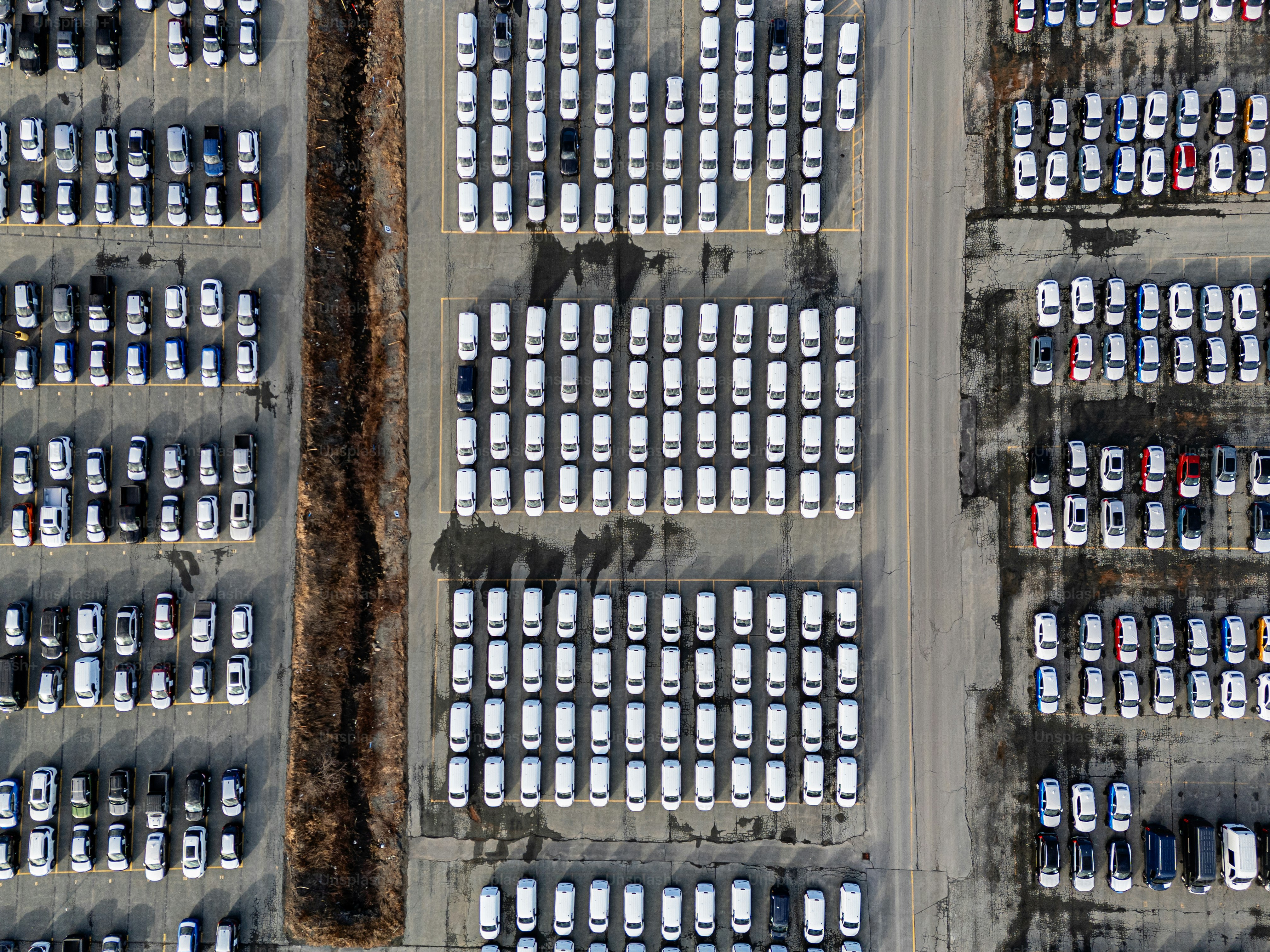 Aerial view of a large autoport where vehicles are transported by rail ...
