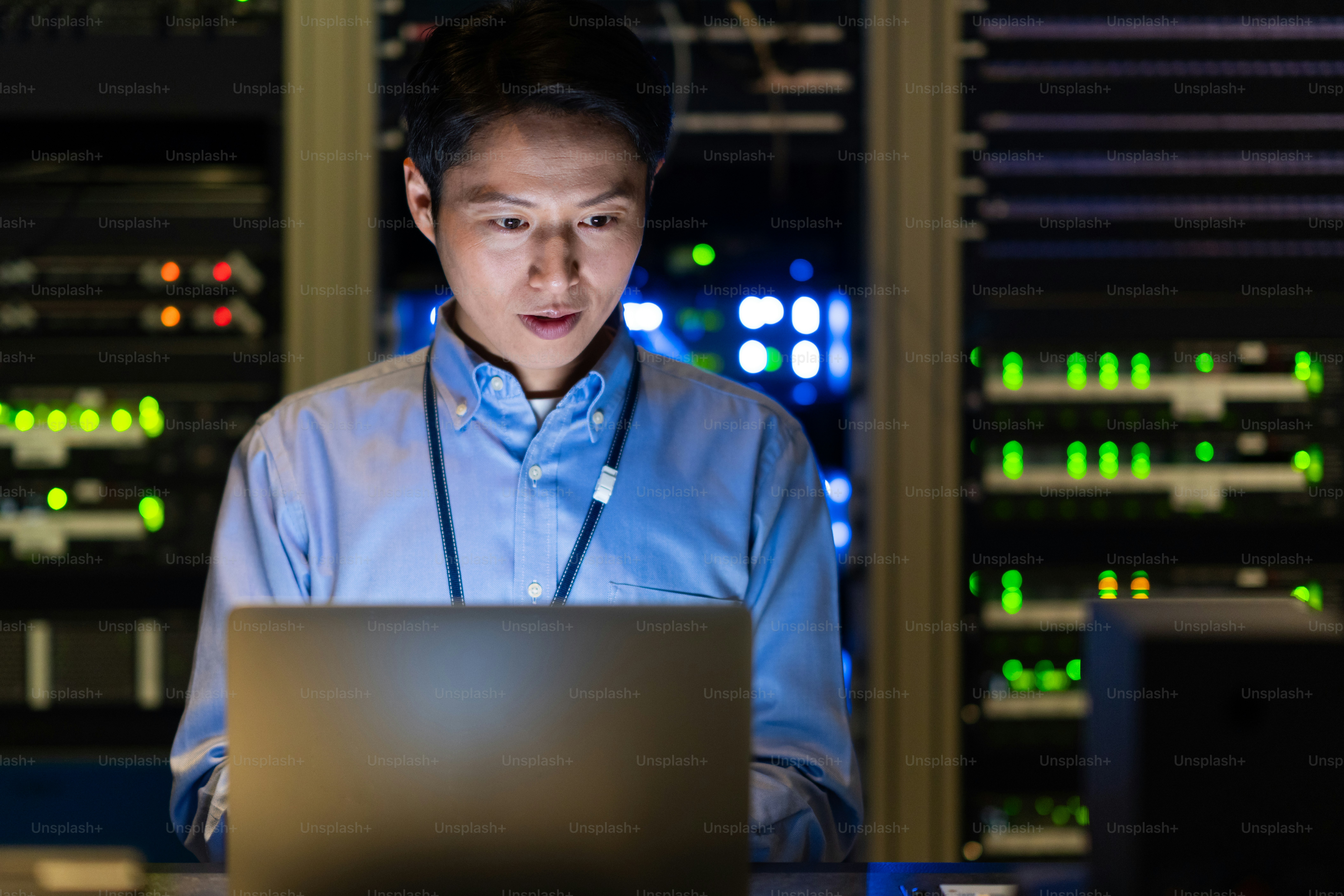 Japanese male engineer working in a server room photo – Business Image ...