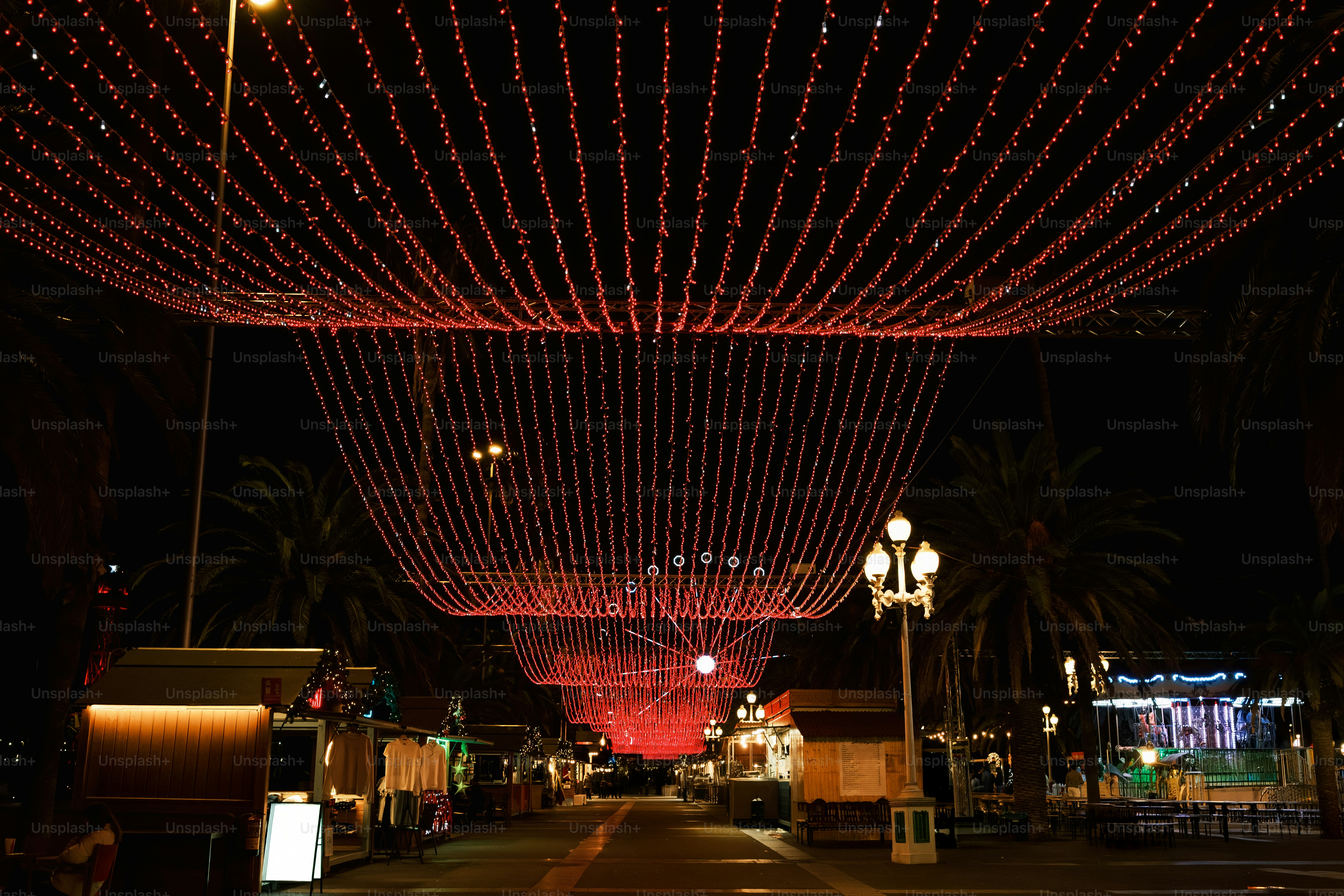 Outdoor string lights illuminate a dark street at night. photo ...