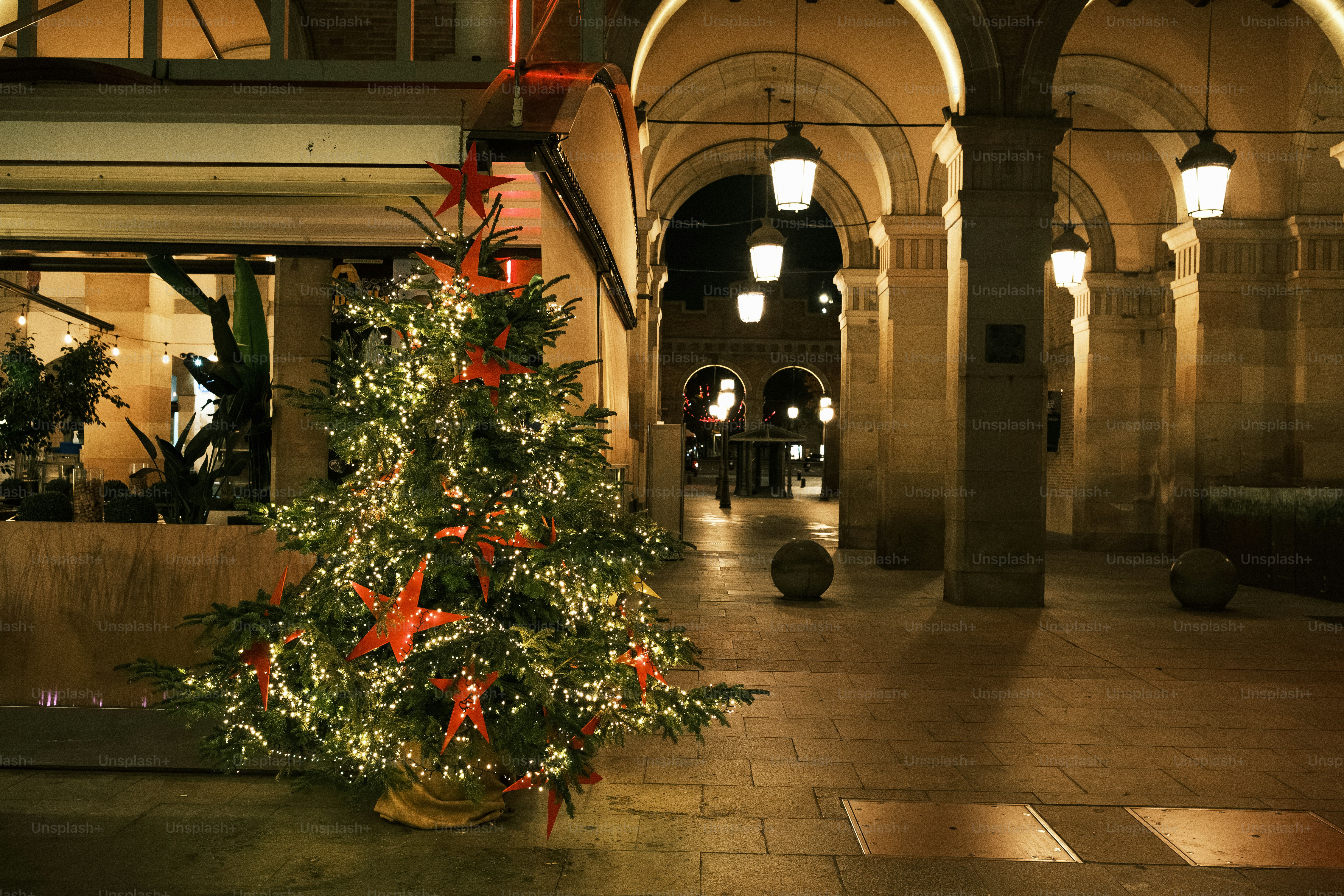 Decorated christmas tree in a nighttime arcade photo – Christmas Image ...