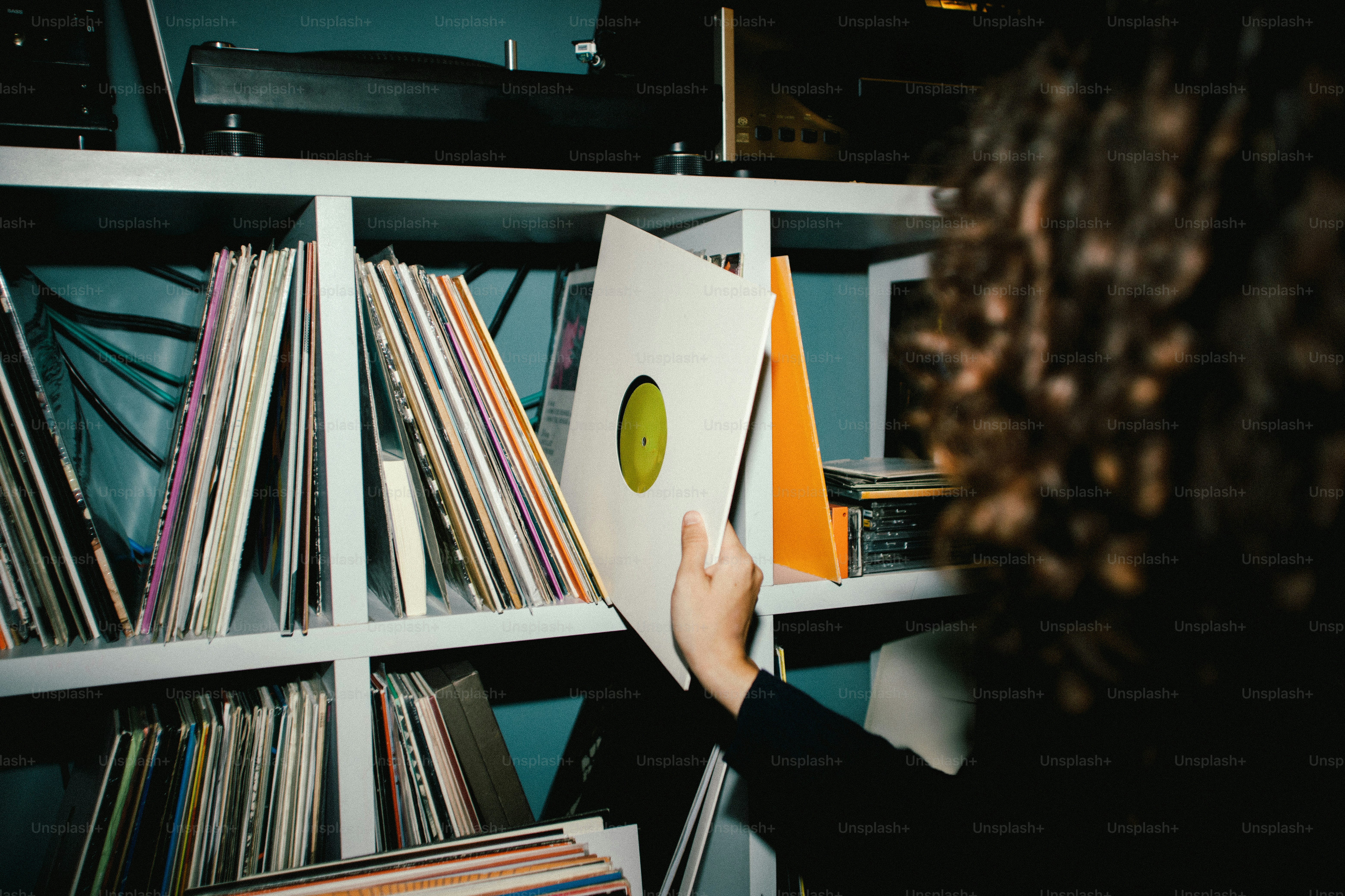 Person browsing vinyl records on a shelf photo – Music Image on Unsplash