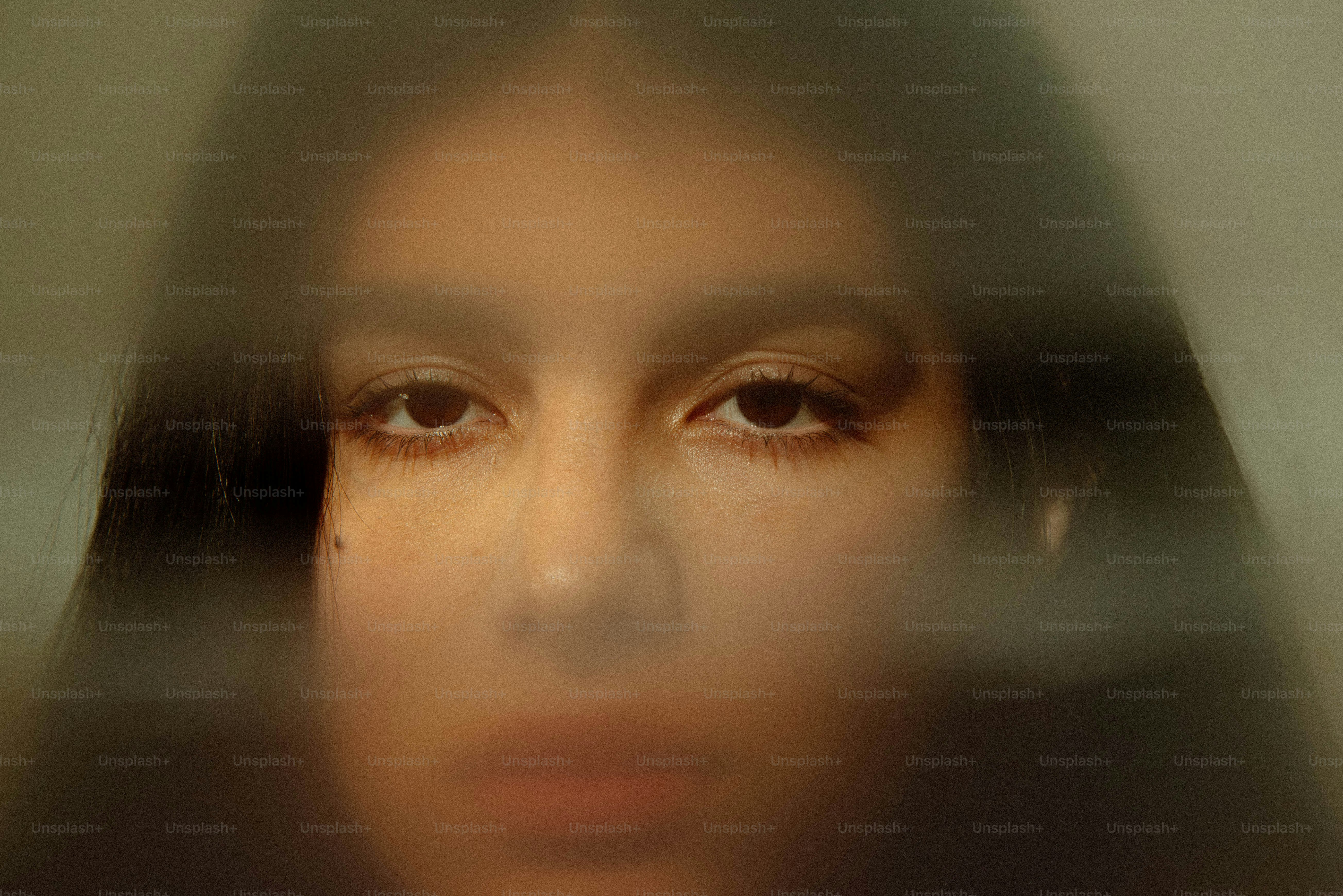 Close-up of a young woman's face through glass photo – Face Image on ...