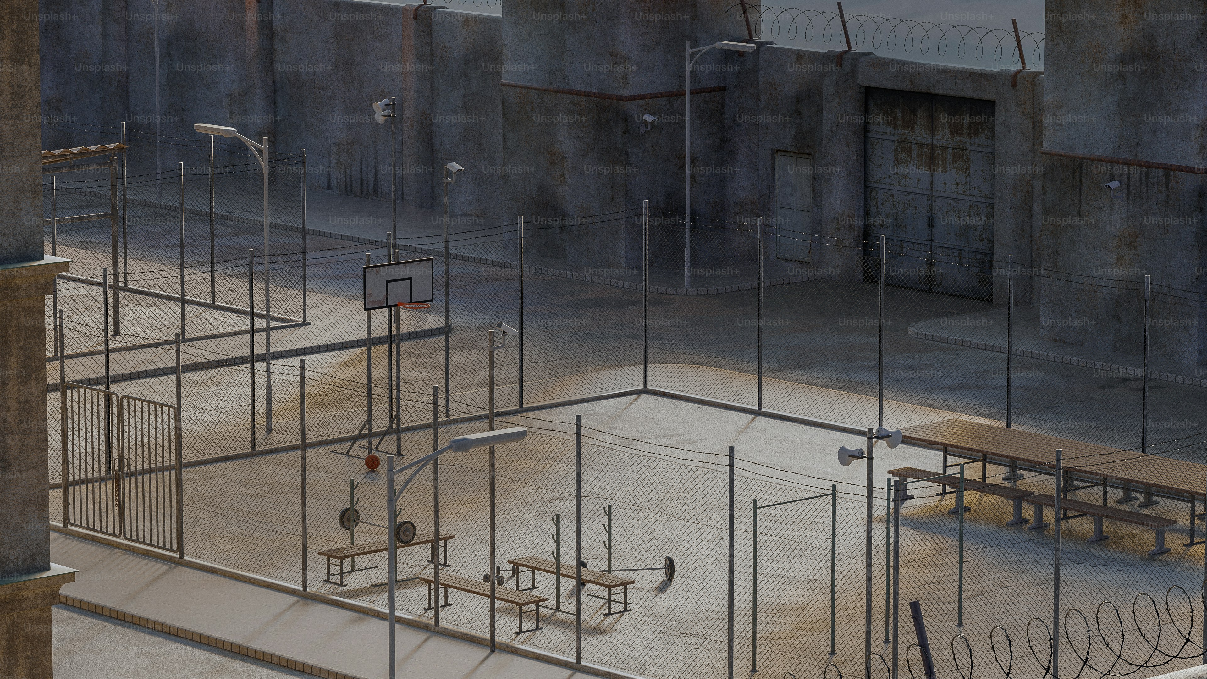 Outdoor prison yard with basketball court and fences photo – Sports ...