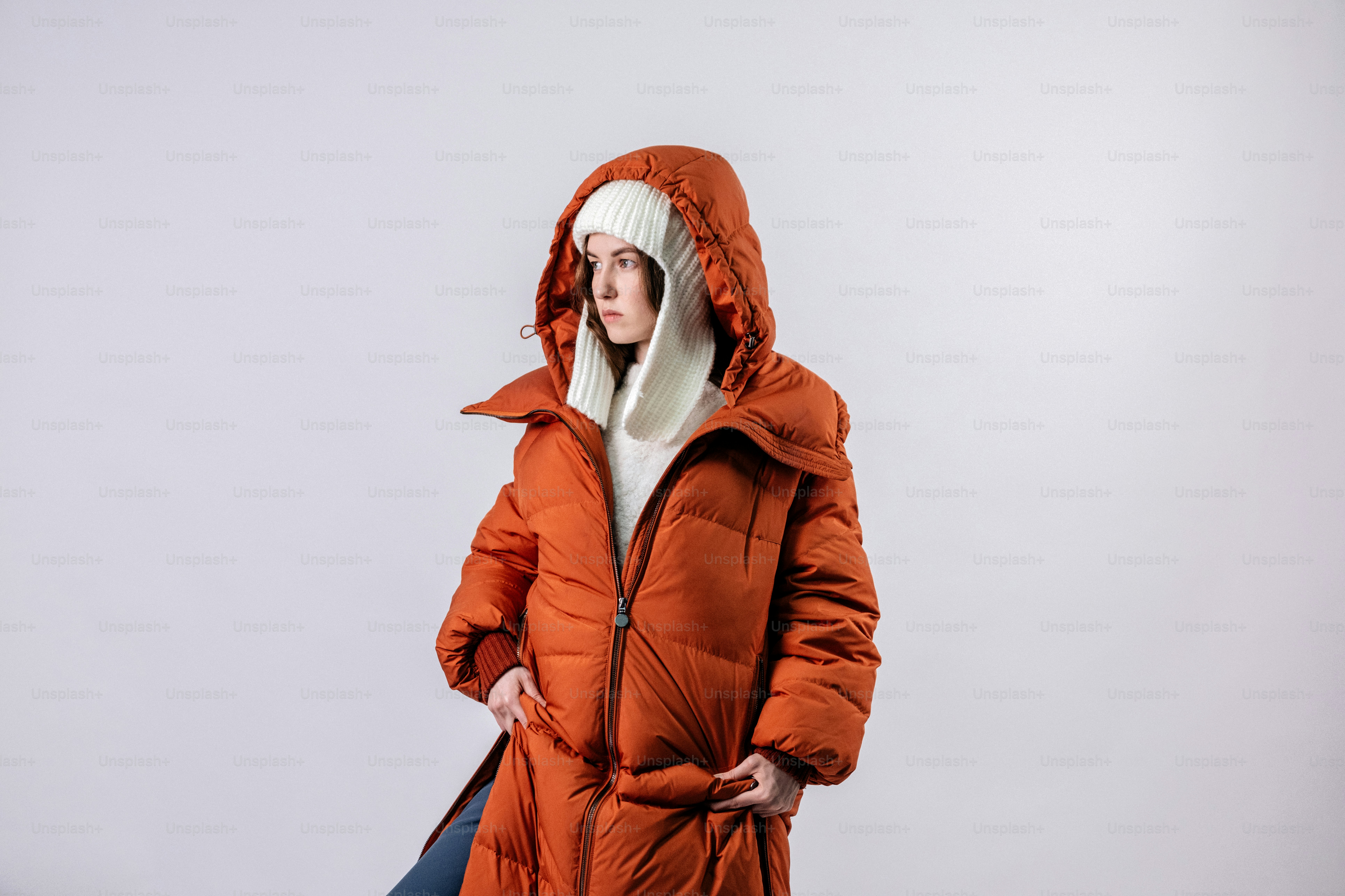Woman in orange puffer jacket and white hat photo – Fashion model Image ...