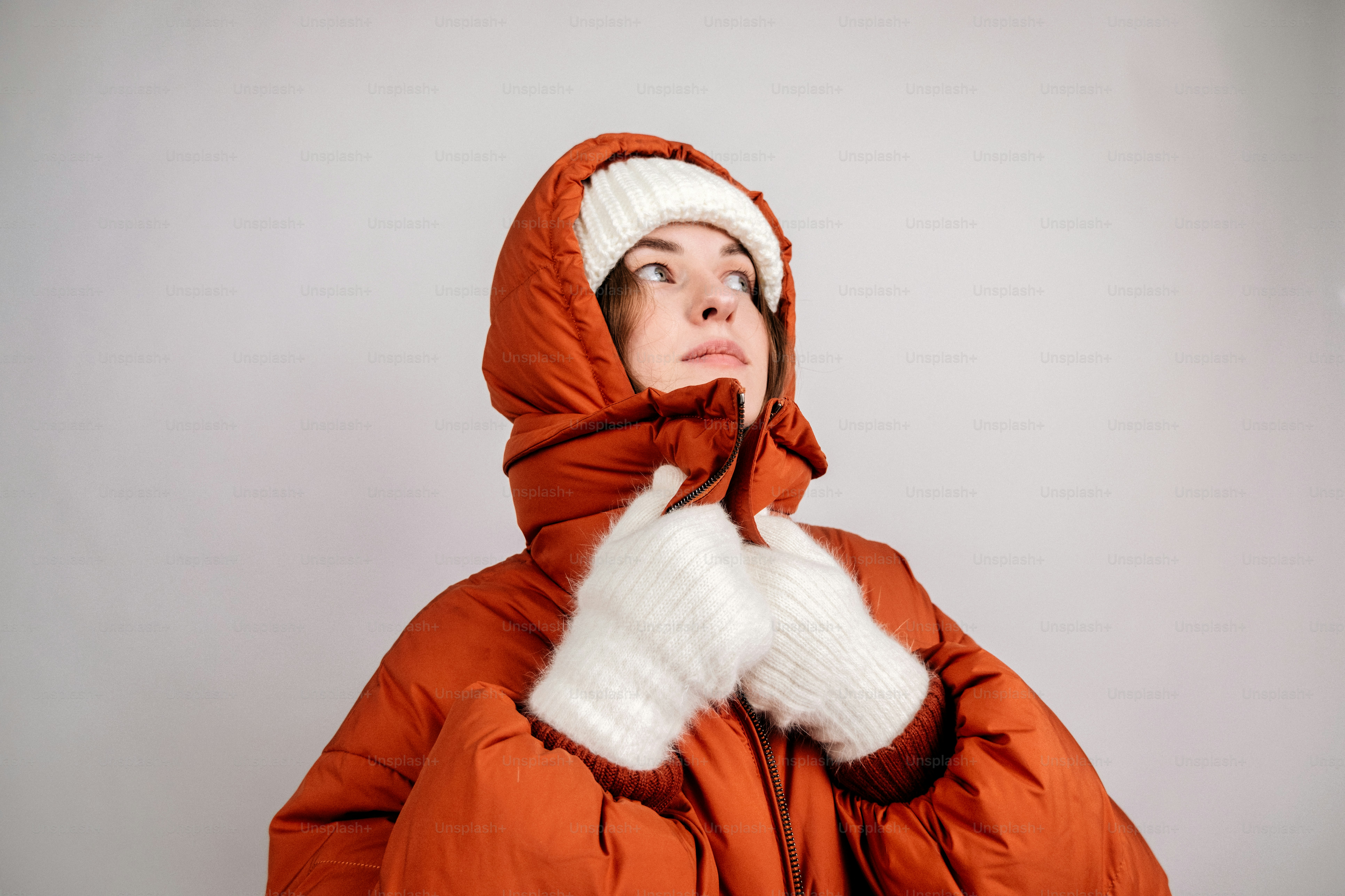 Woman in orange puffer jacket and white hat photo – Fashion model Image ...