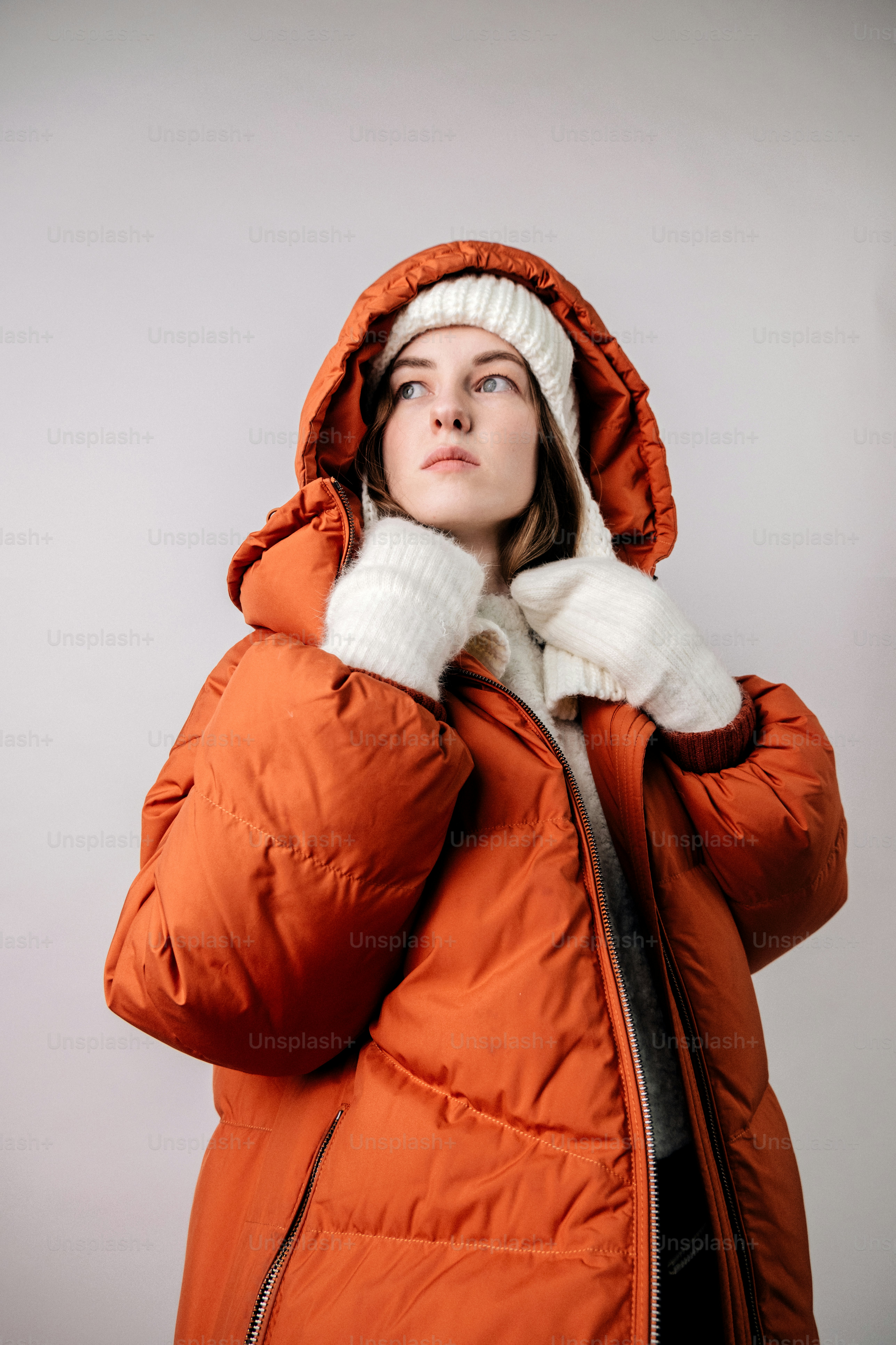 Woman in orange puffer jacket and white hat photo – Fashion model Image ...