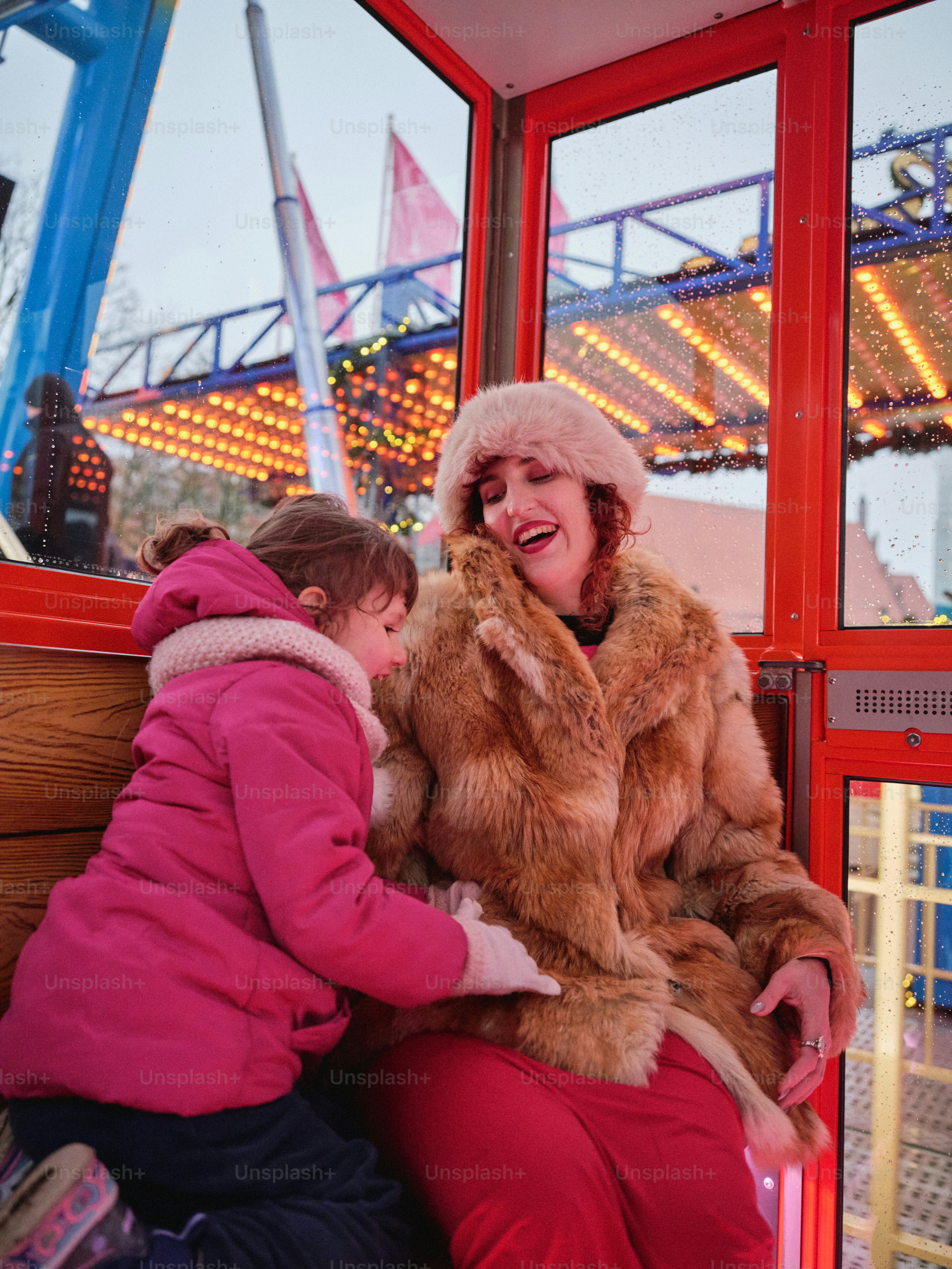 Woman feeding child on a carousel ride photo – Christmas Image on Unsplash