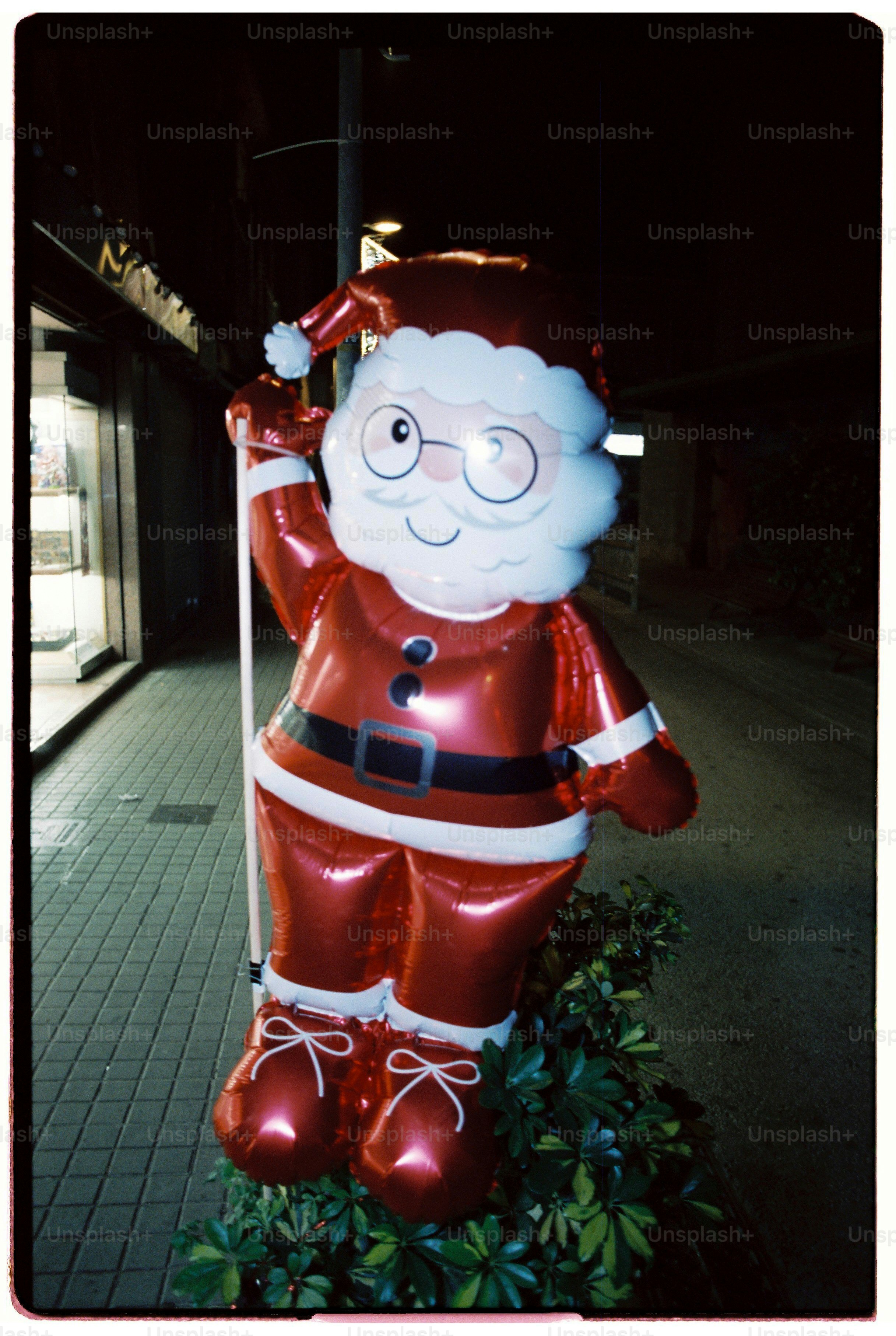 Inflatable santa claus decoration on street at night photo – Christmas ...