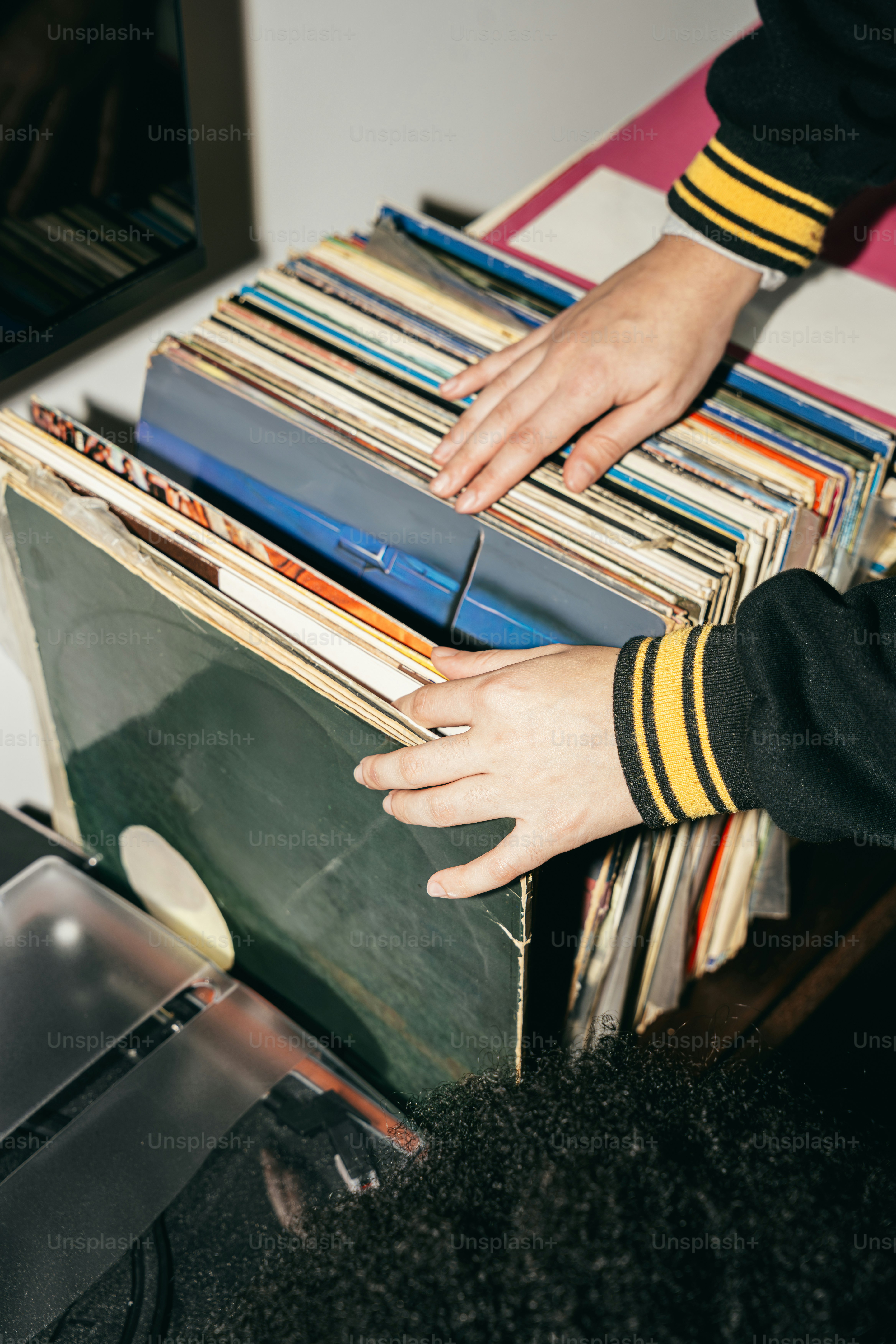 Hands sorting through a stack of vinyl records photo – Music Image on ...