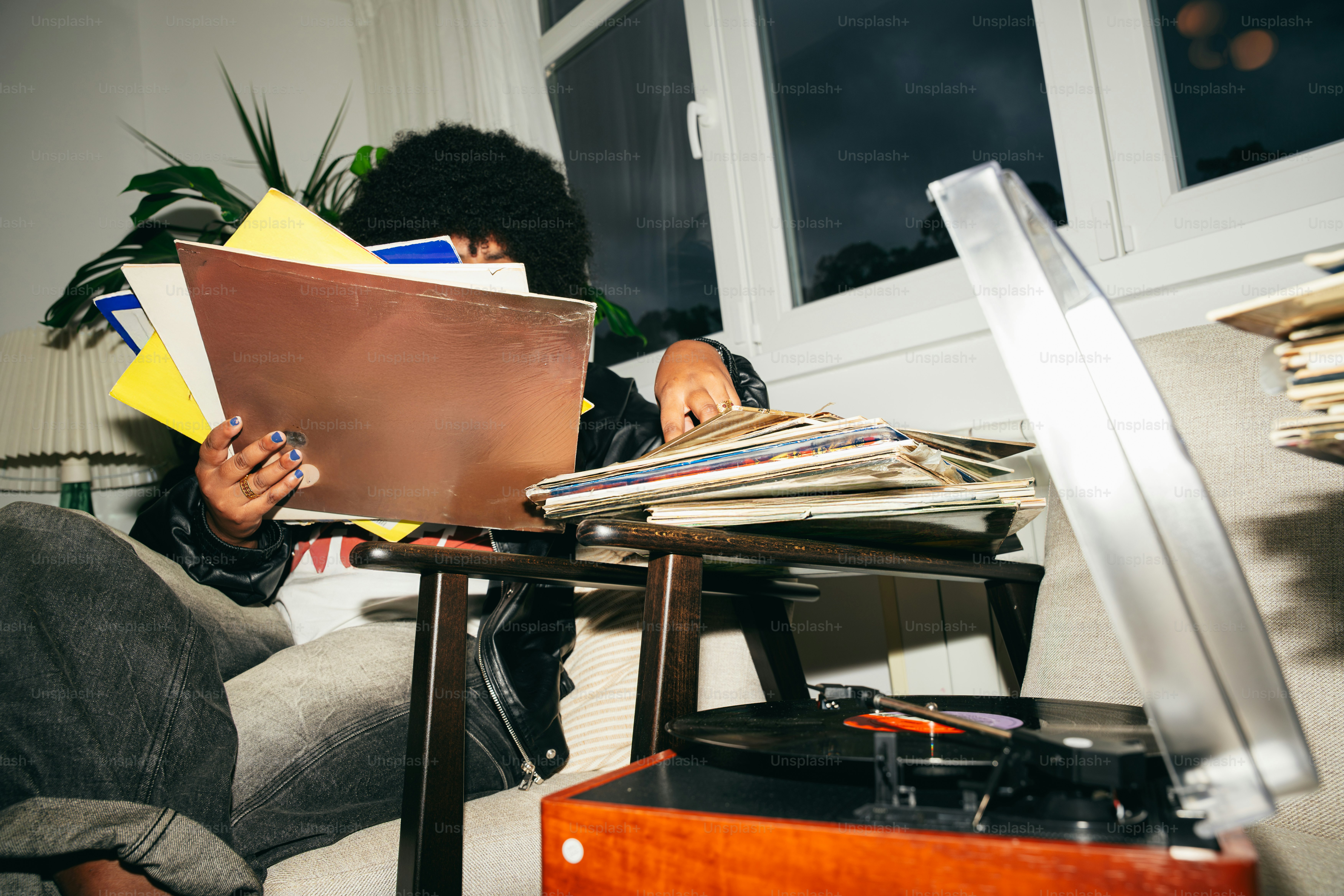 Person looking through vinyl records near turntable photo – Music Image ...
