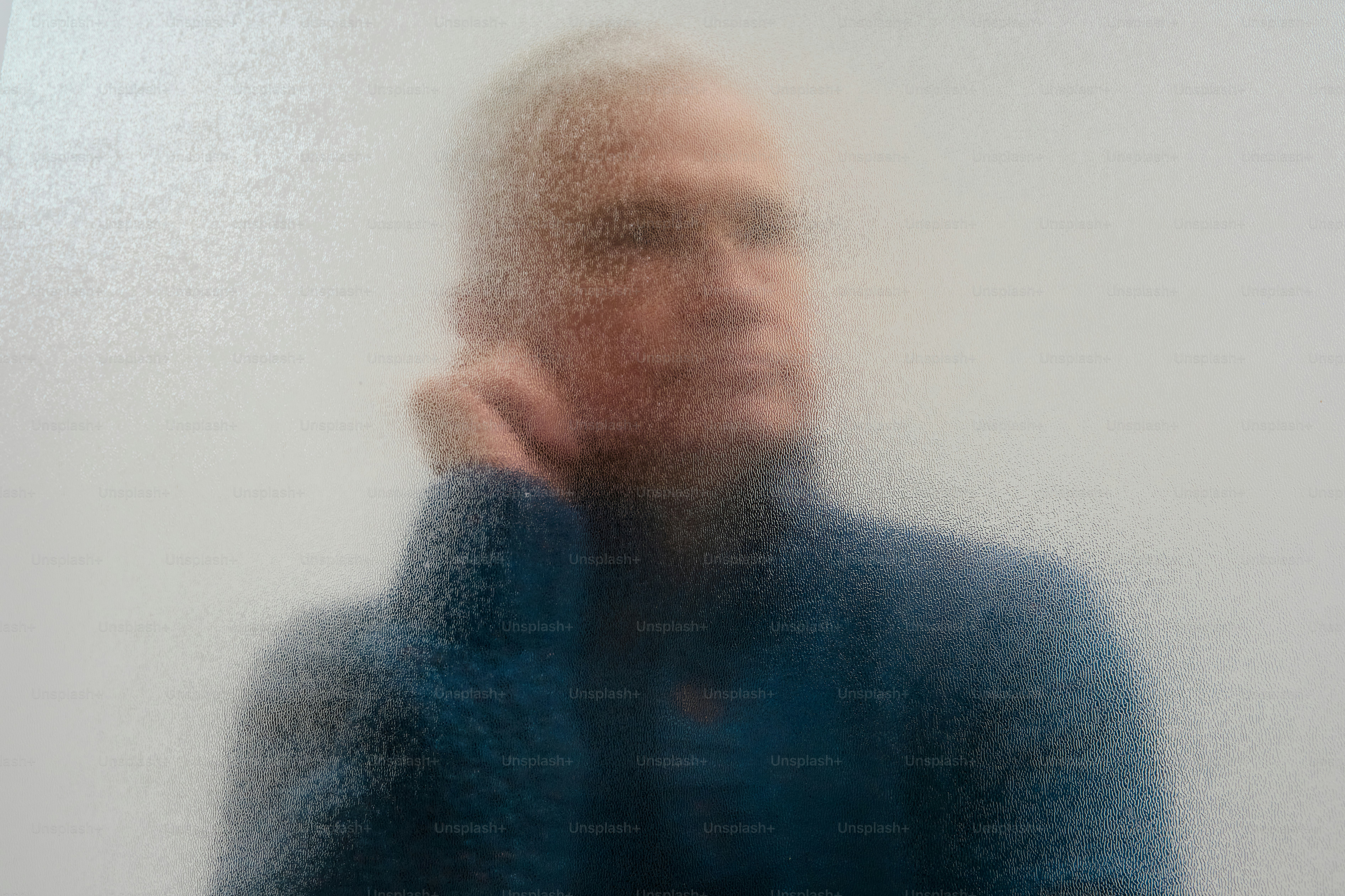 Man behind frosted glass with hand to ear photo – Portrait Image on ...
