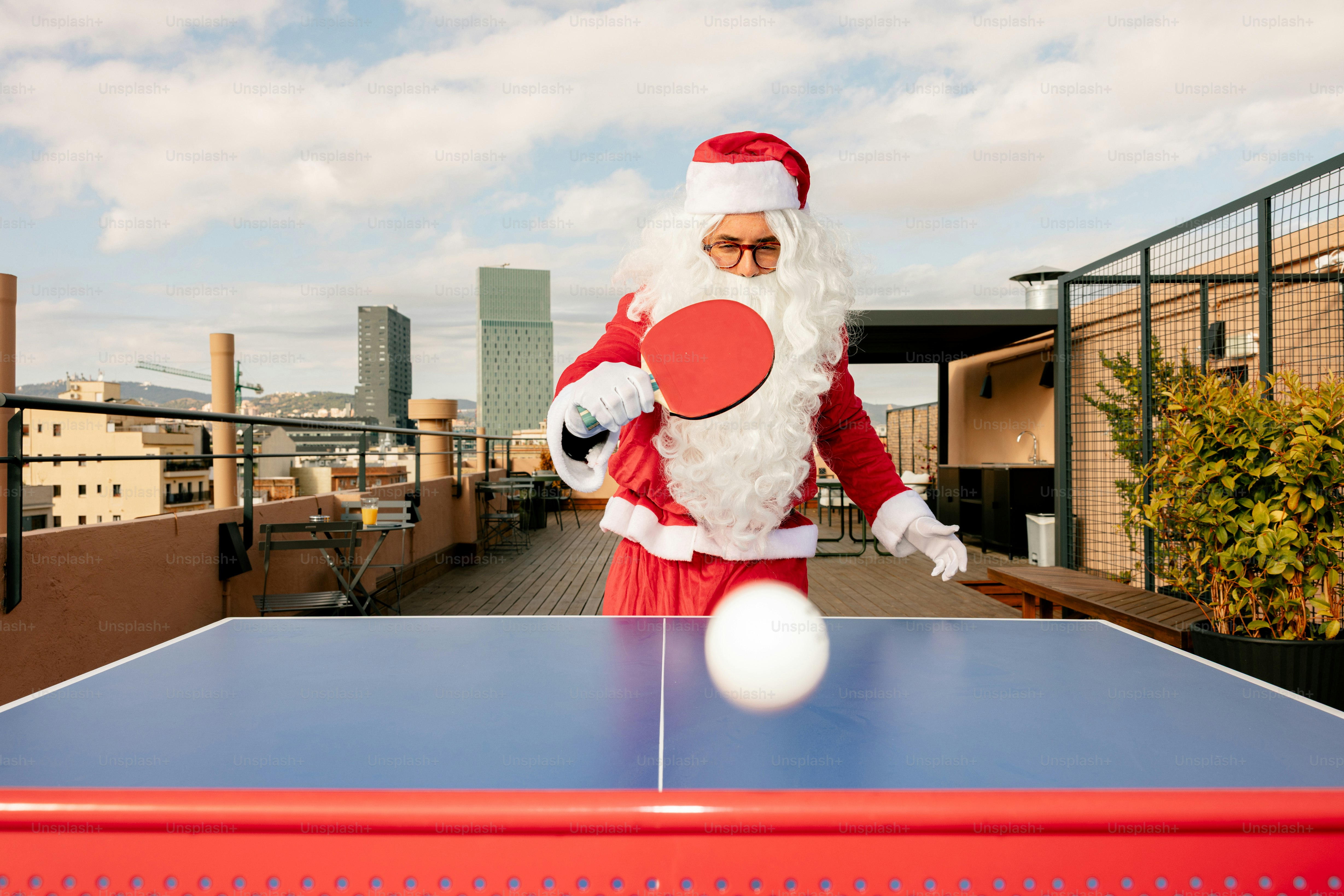 Santa playing ping pong on a rooftop photo – Cityscape Image on Unsplash