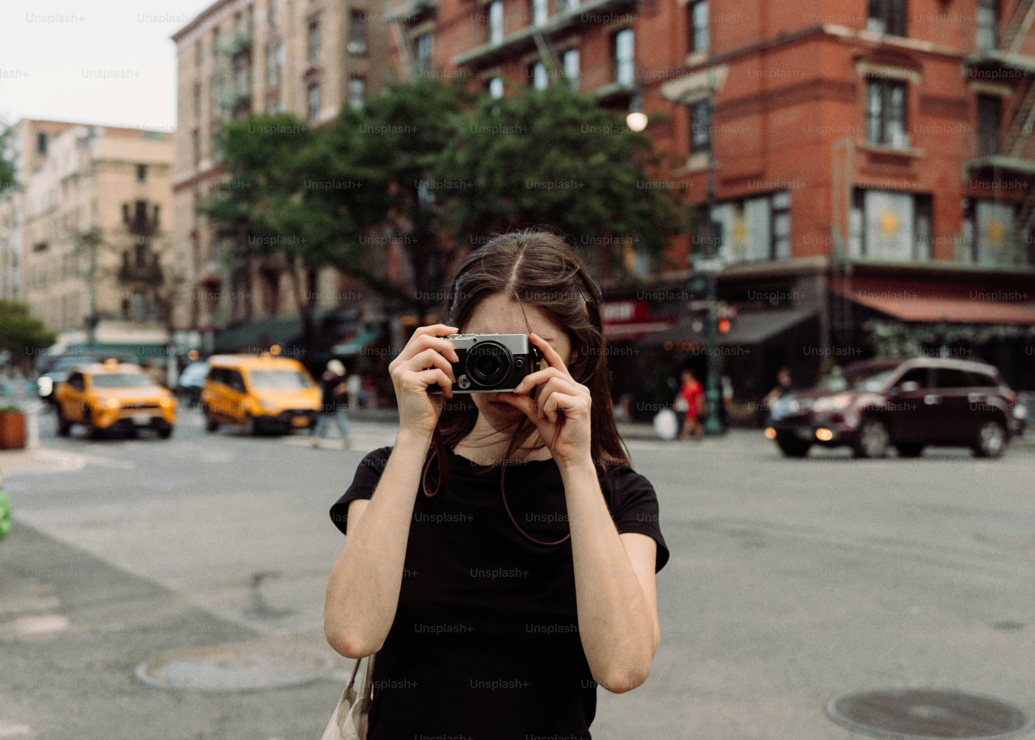 Woman taking a picture with a camera on street photo – Travel Image on ...
