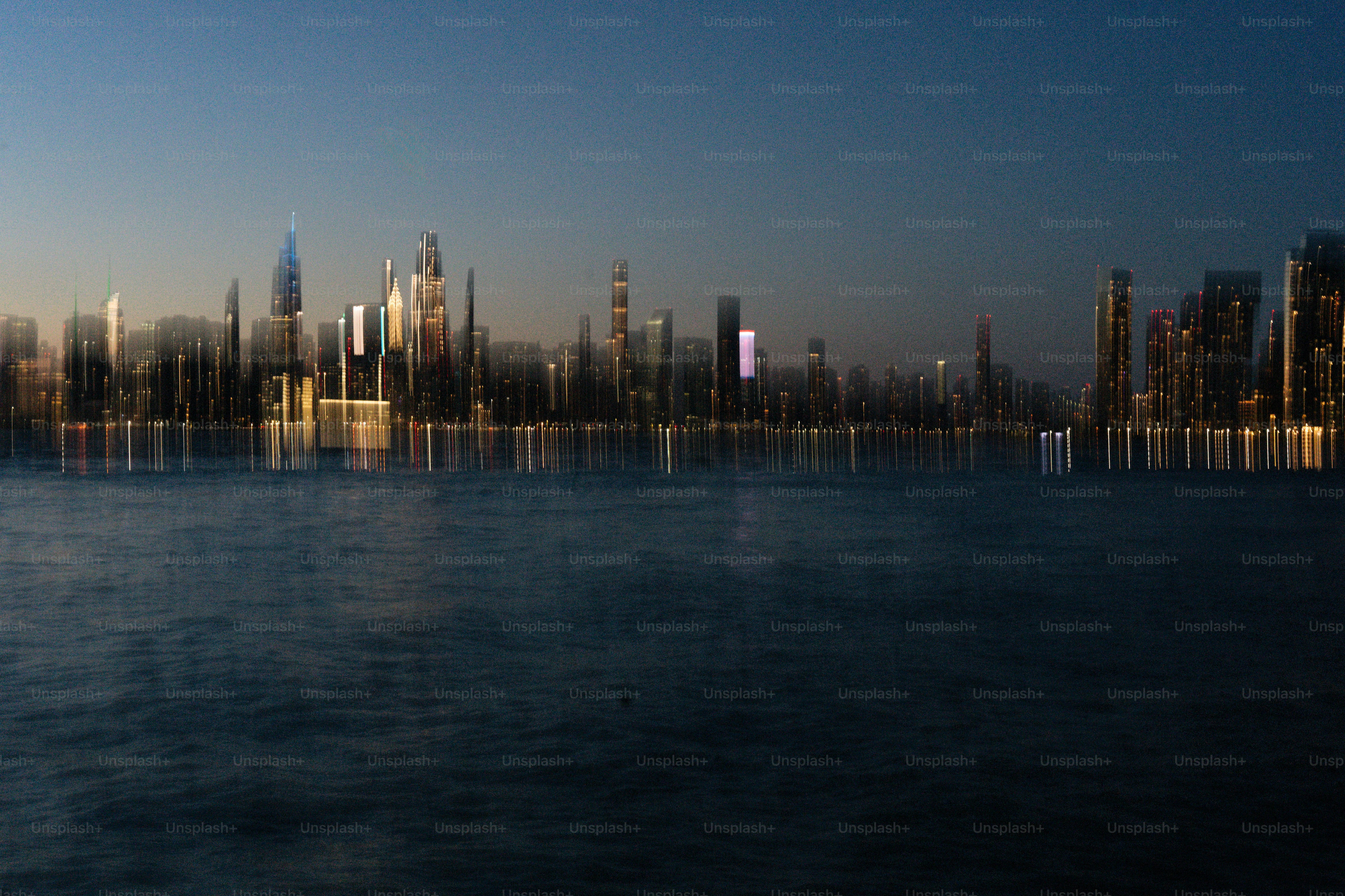 City skyline at dusk with water reflections photo – New york Image on ...