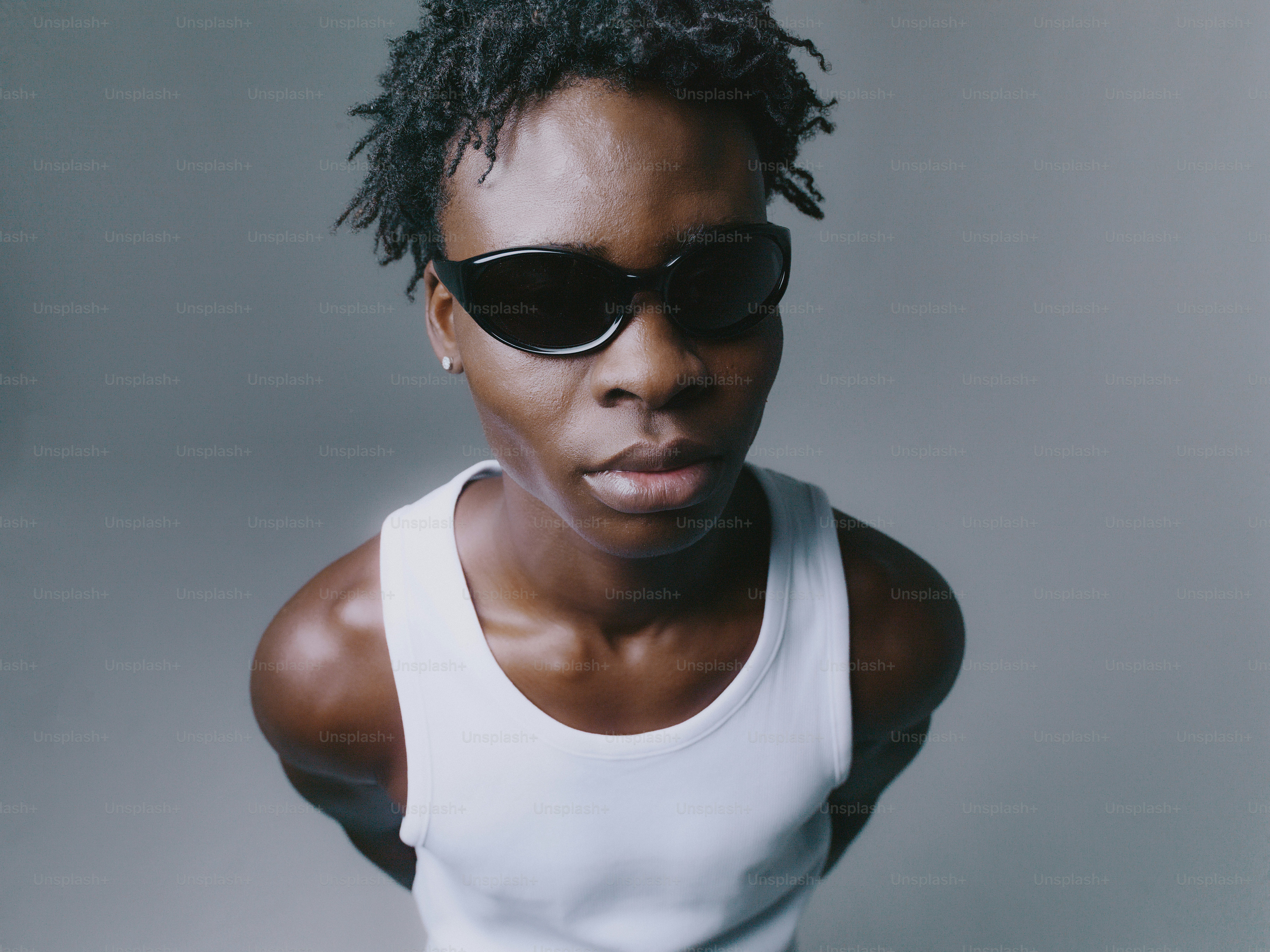Young man wearing a fur hat and tank top photo – Portrait Image on Unsplash