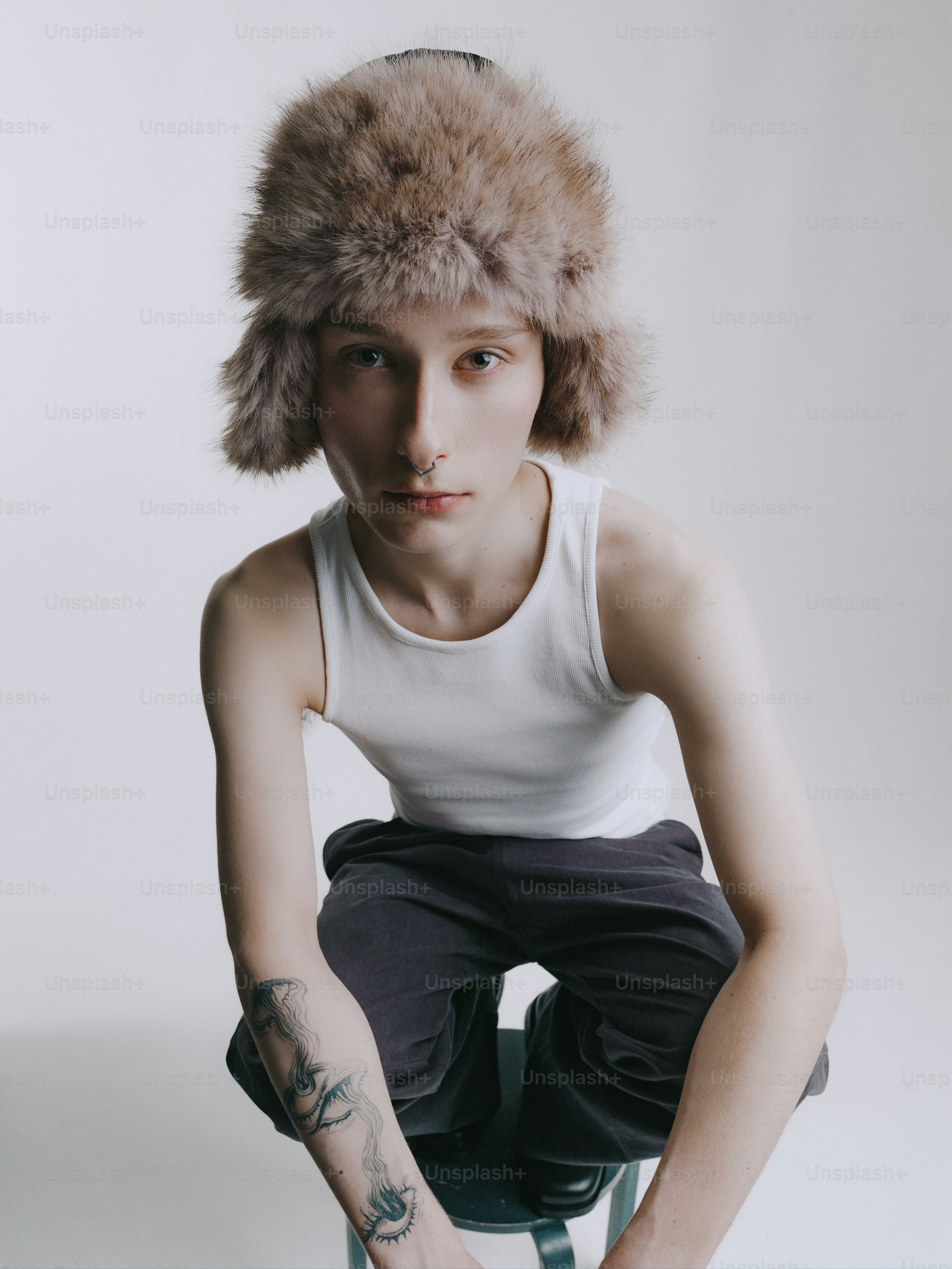 Young man wearing a fur hat and tank top photo – Portrait Image on Unsplash