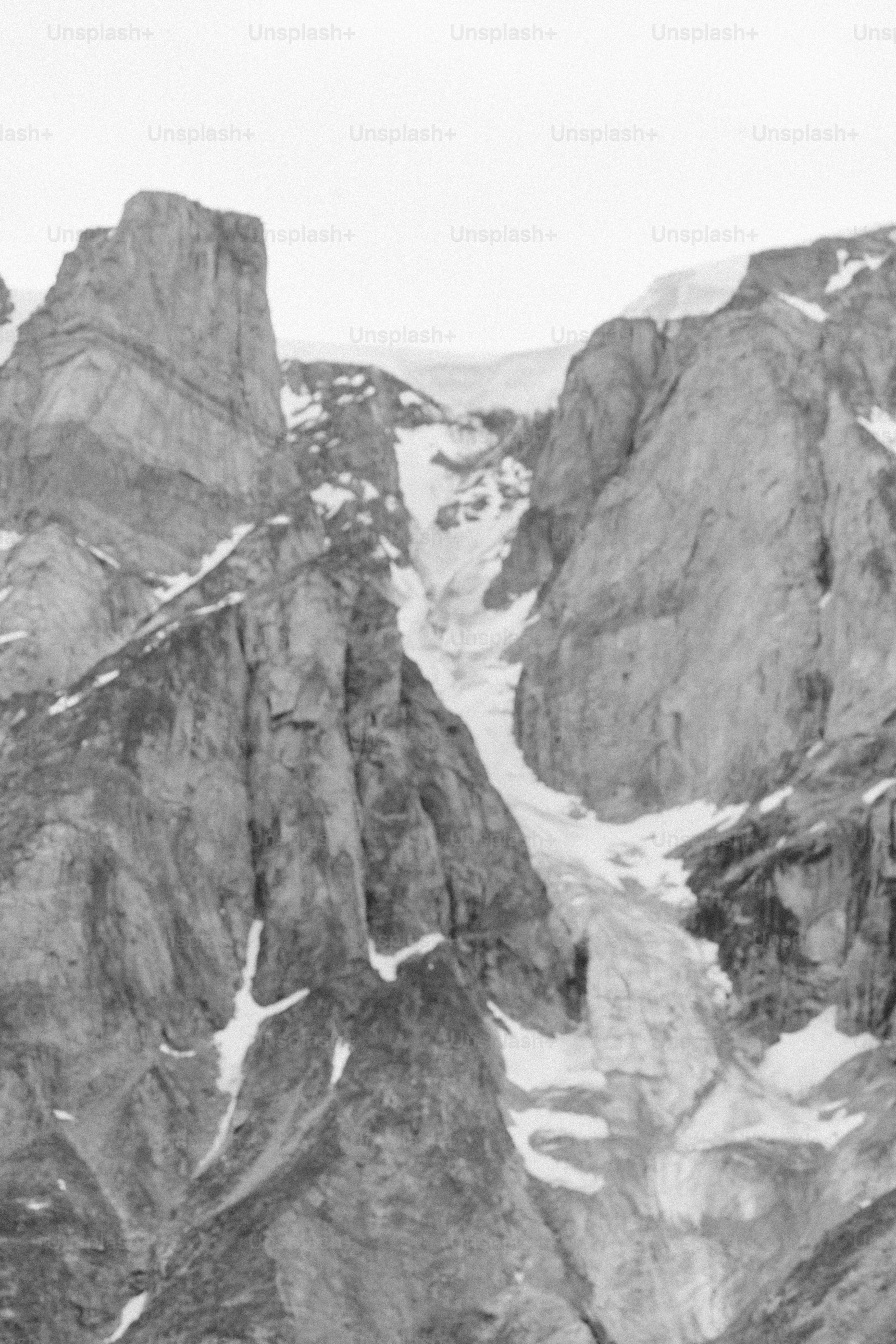 Snow covered mountain peak with rocky slopes photo – Mountains Image on ...