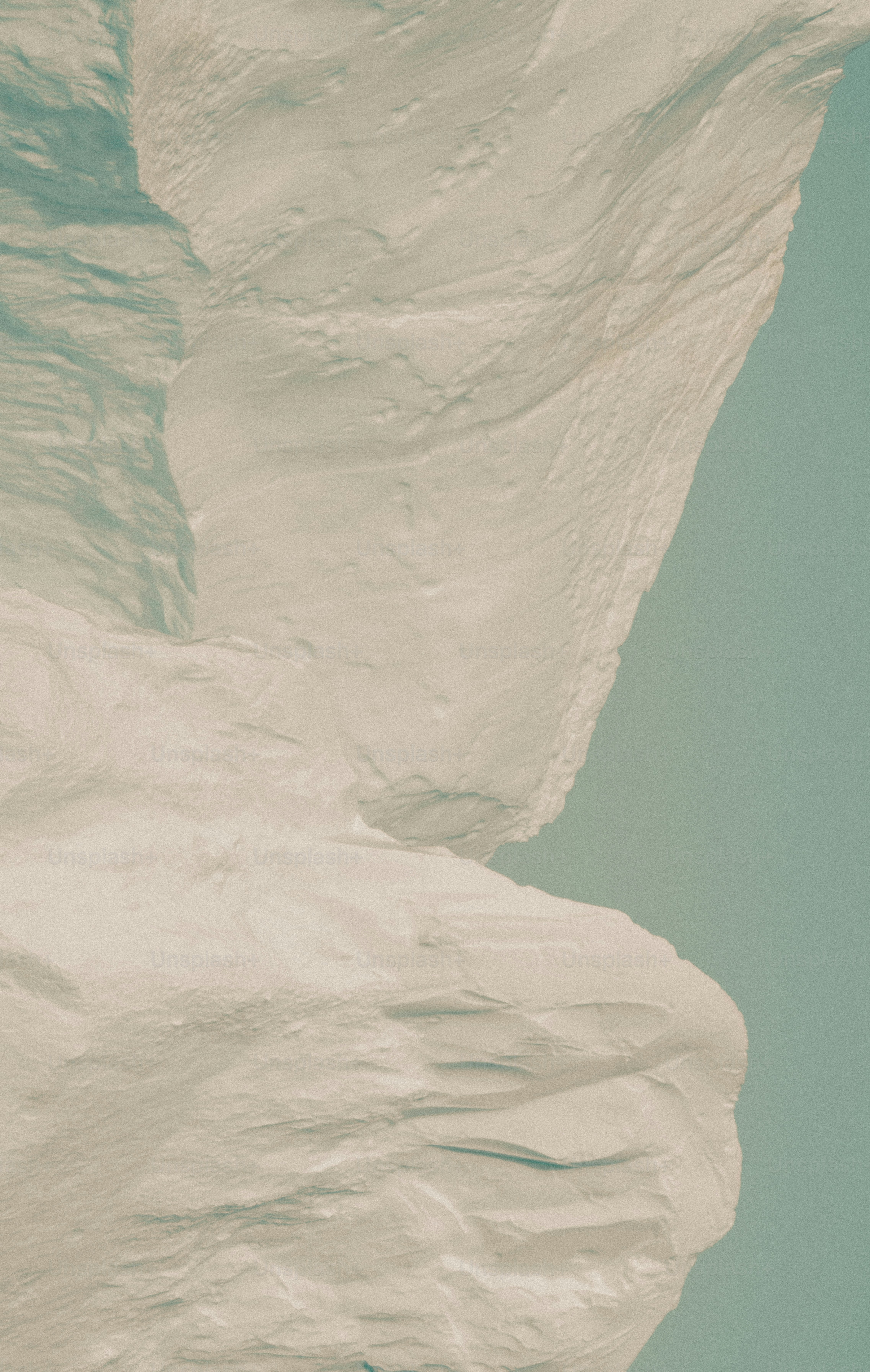 Abstract textured white surface against a teal background photo ...