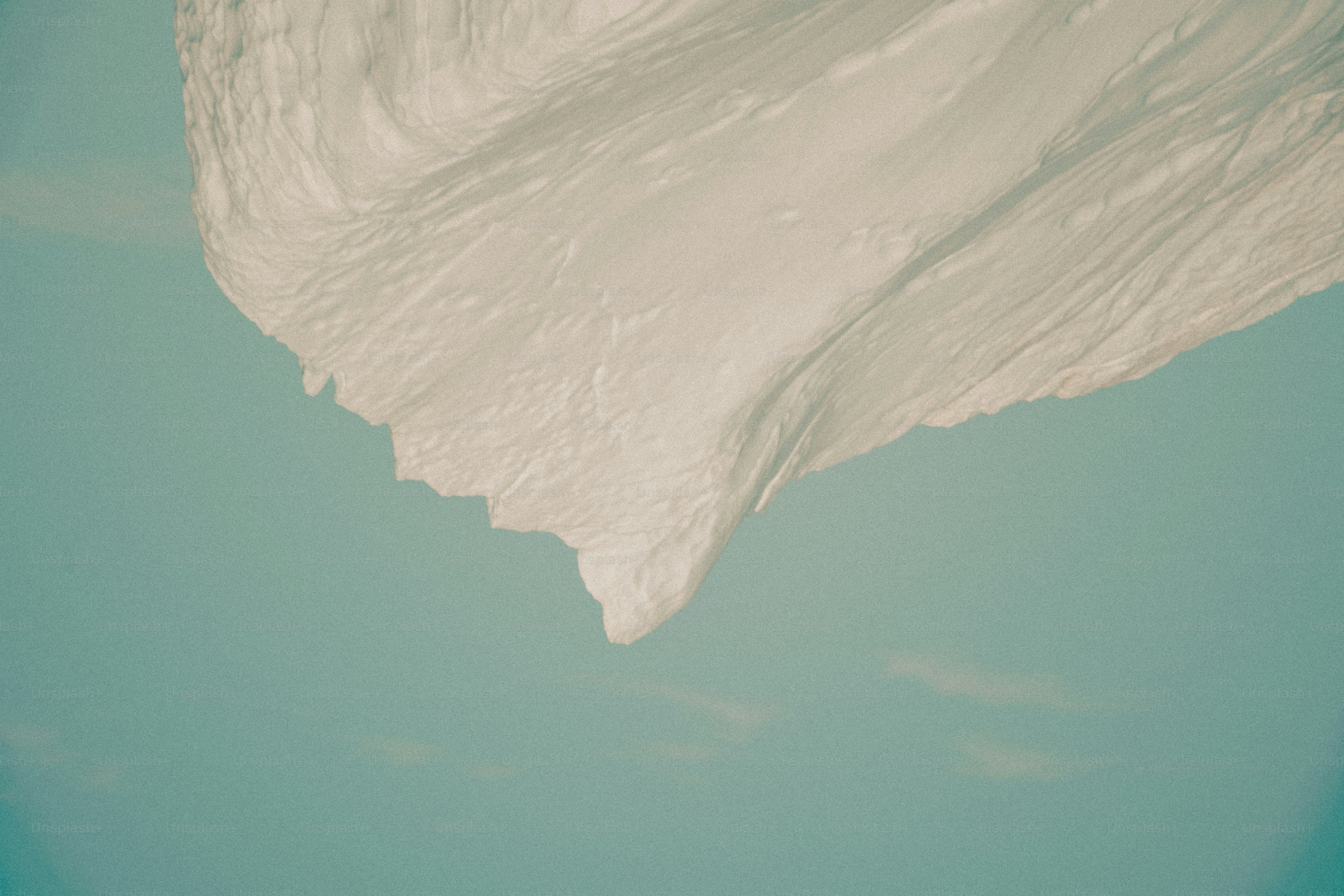 Abstract textured white surface against a teal background photo ...