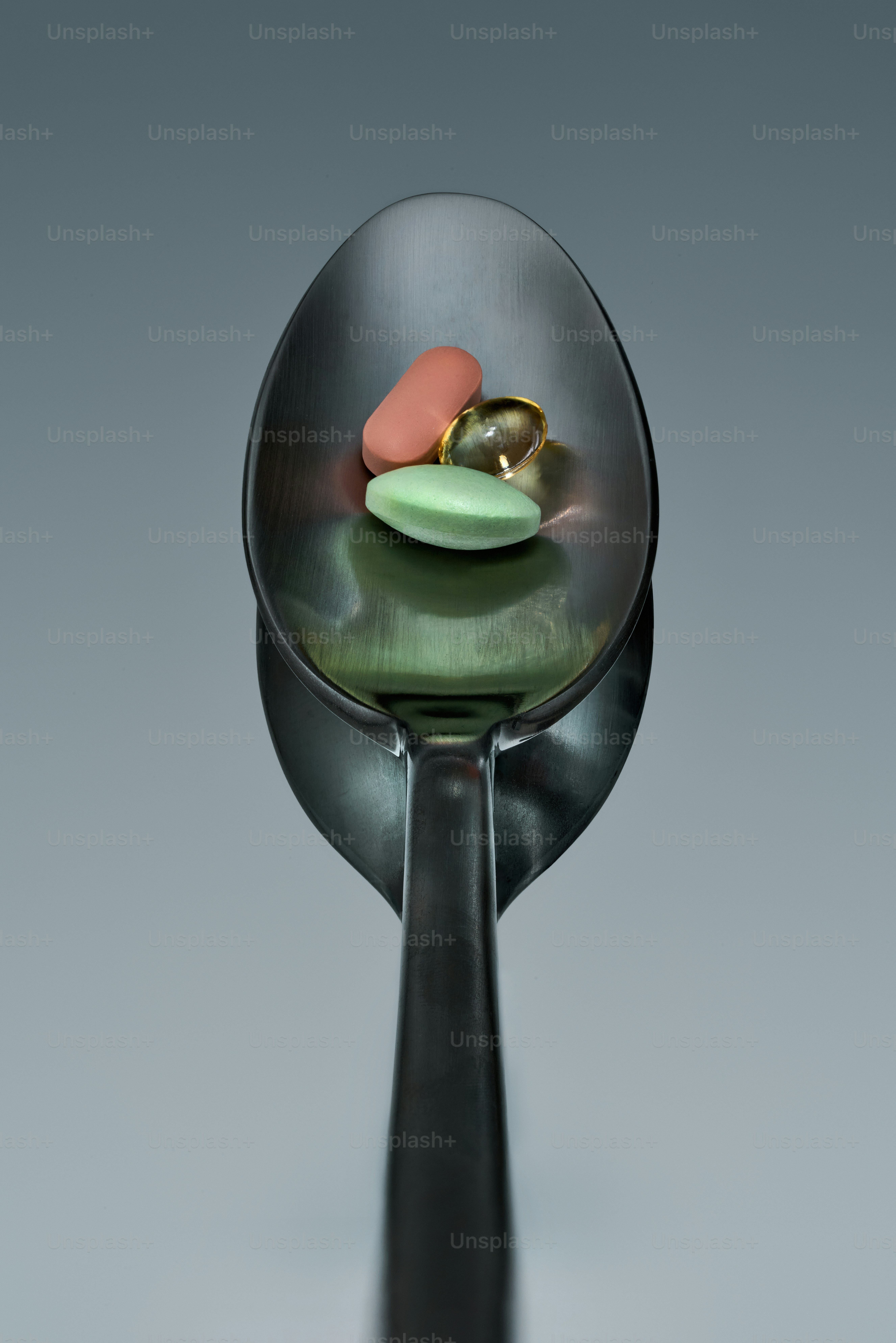 Three pills on a metal spoon. photo – Health Image on Unsplash