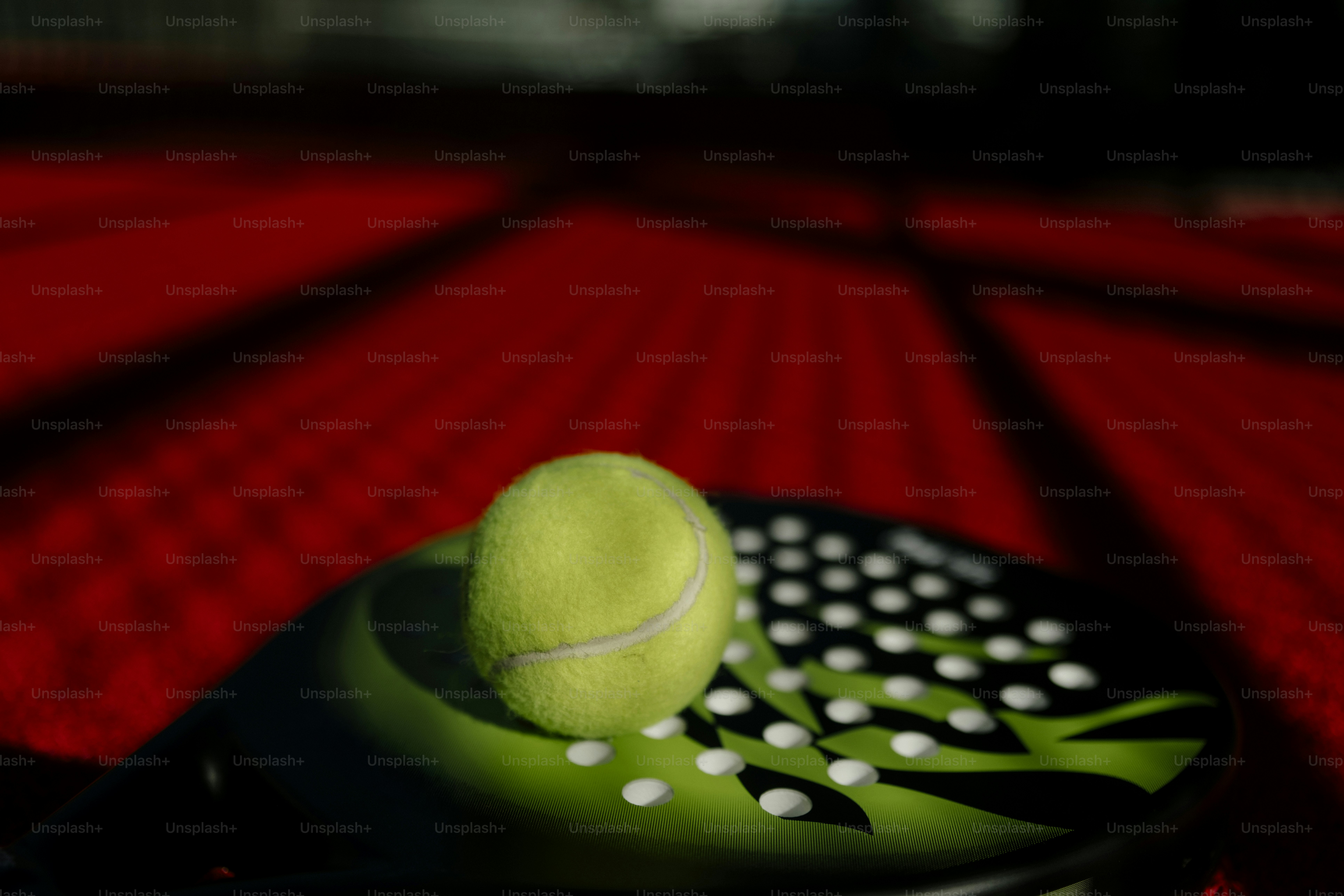 Shadows of a tennis racket and balls on red surface photo – Game Image ...