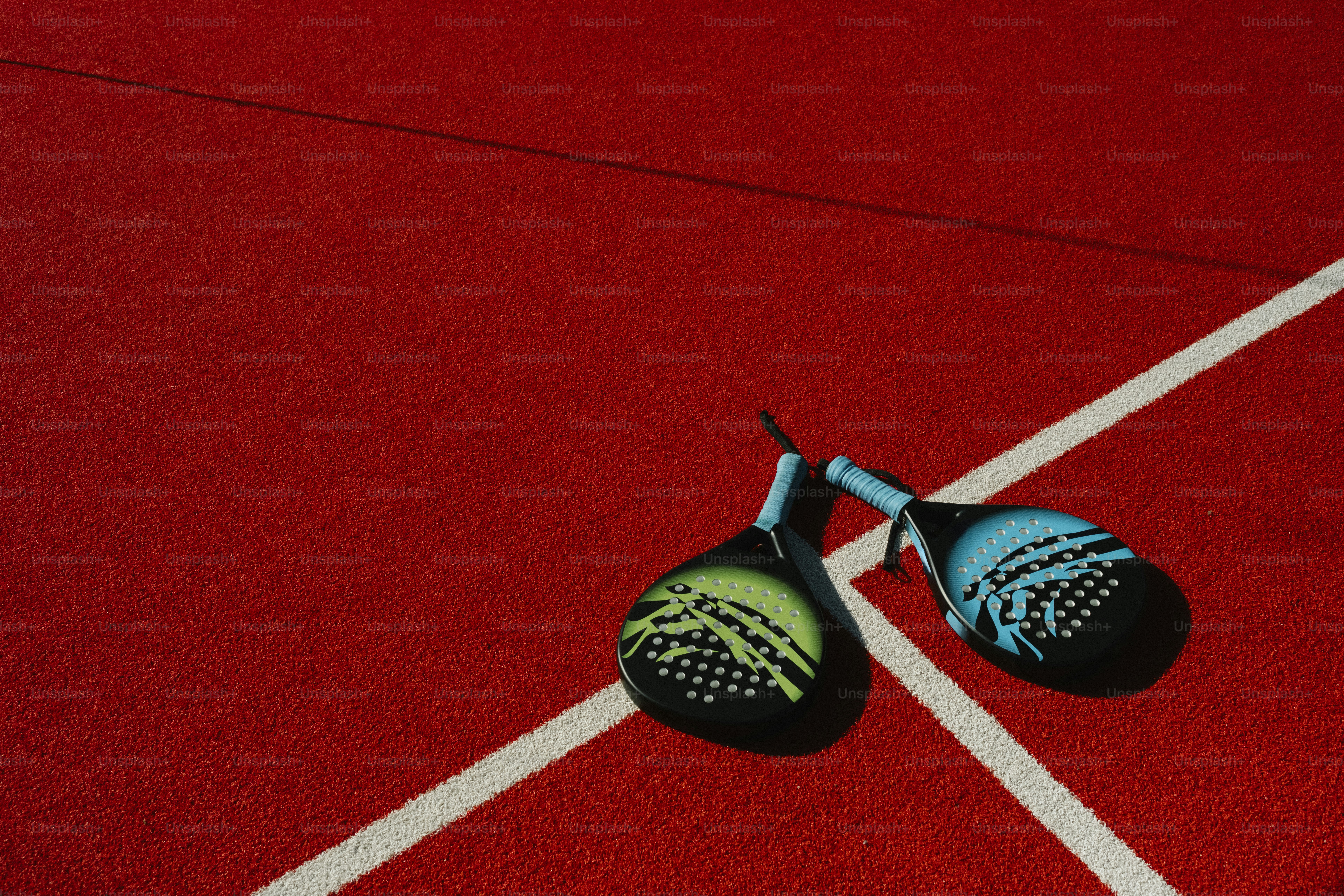 Shadows of a tennis racket and balls on red surface photo – Game Image ...