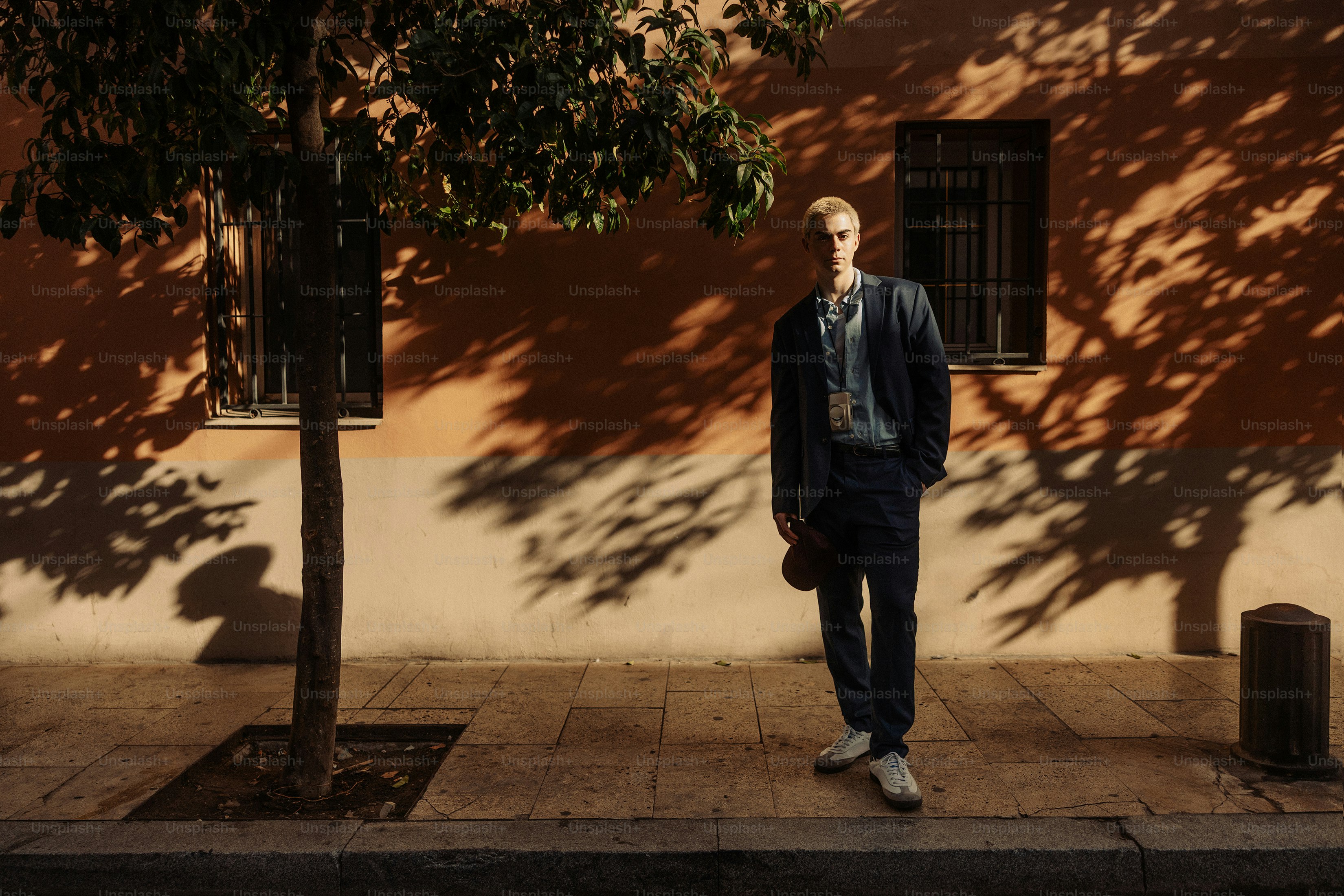 Man in suit walks away with shadow of tree photo – Freedom Image on ...