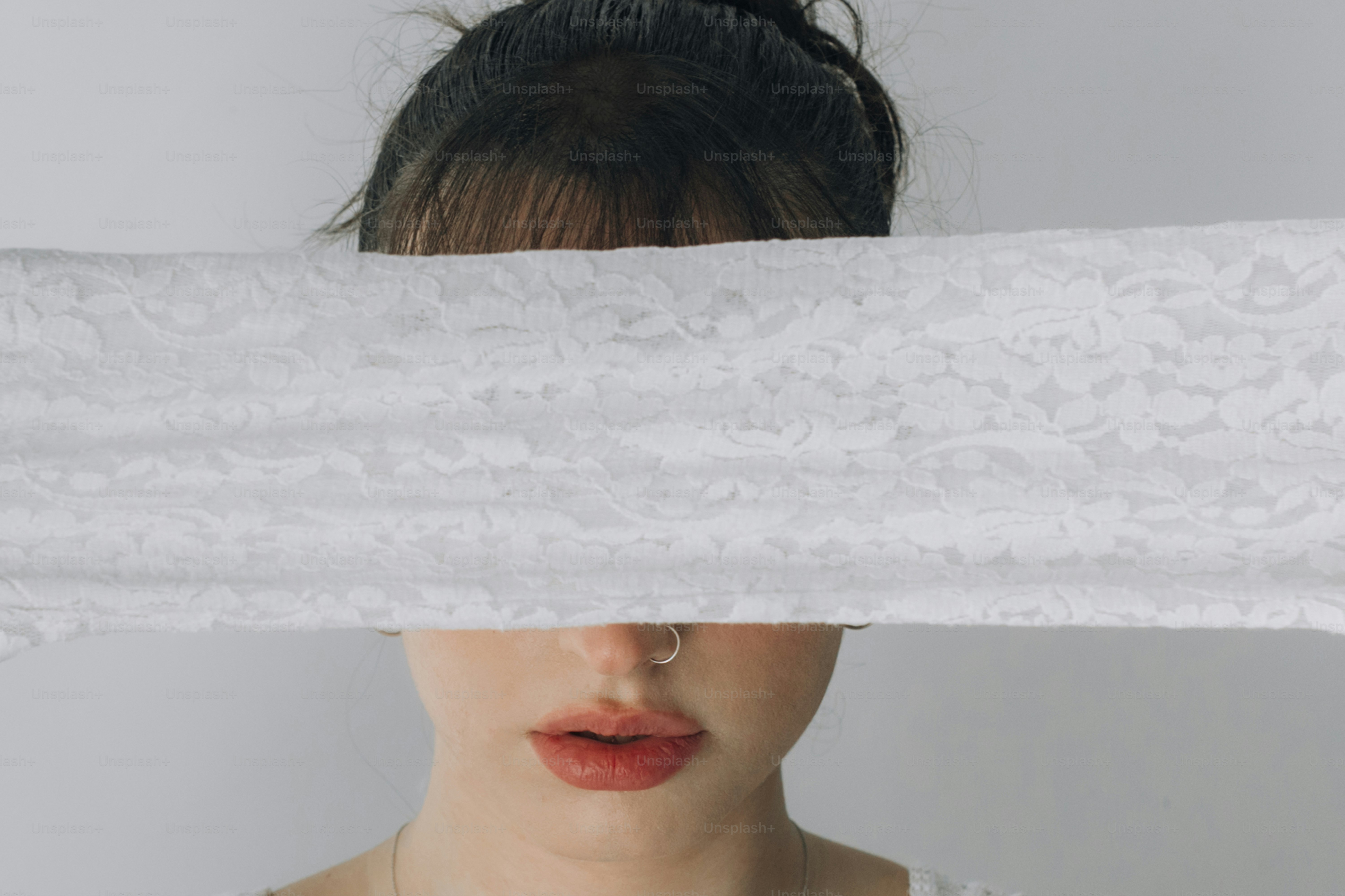 Young woman in flowing white fabric against white background photo ...