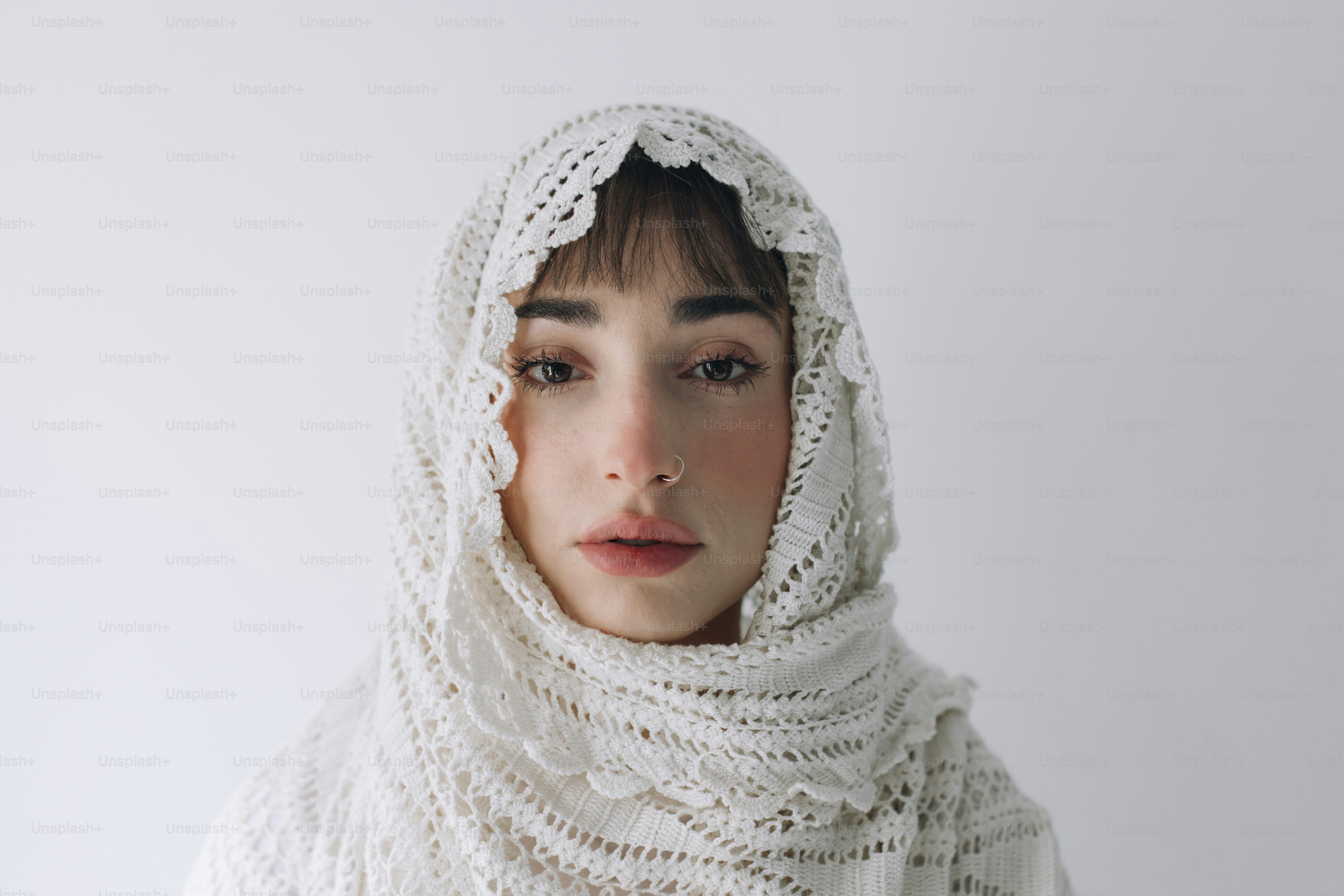Young woman in flowing white fabric against white background photo ...