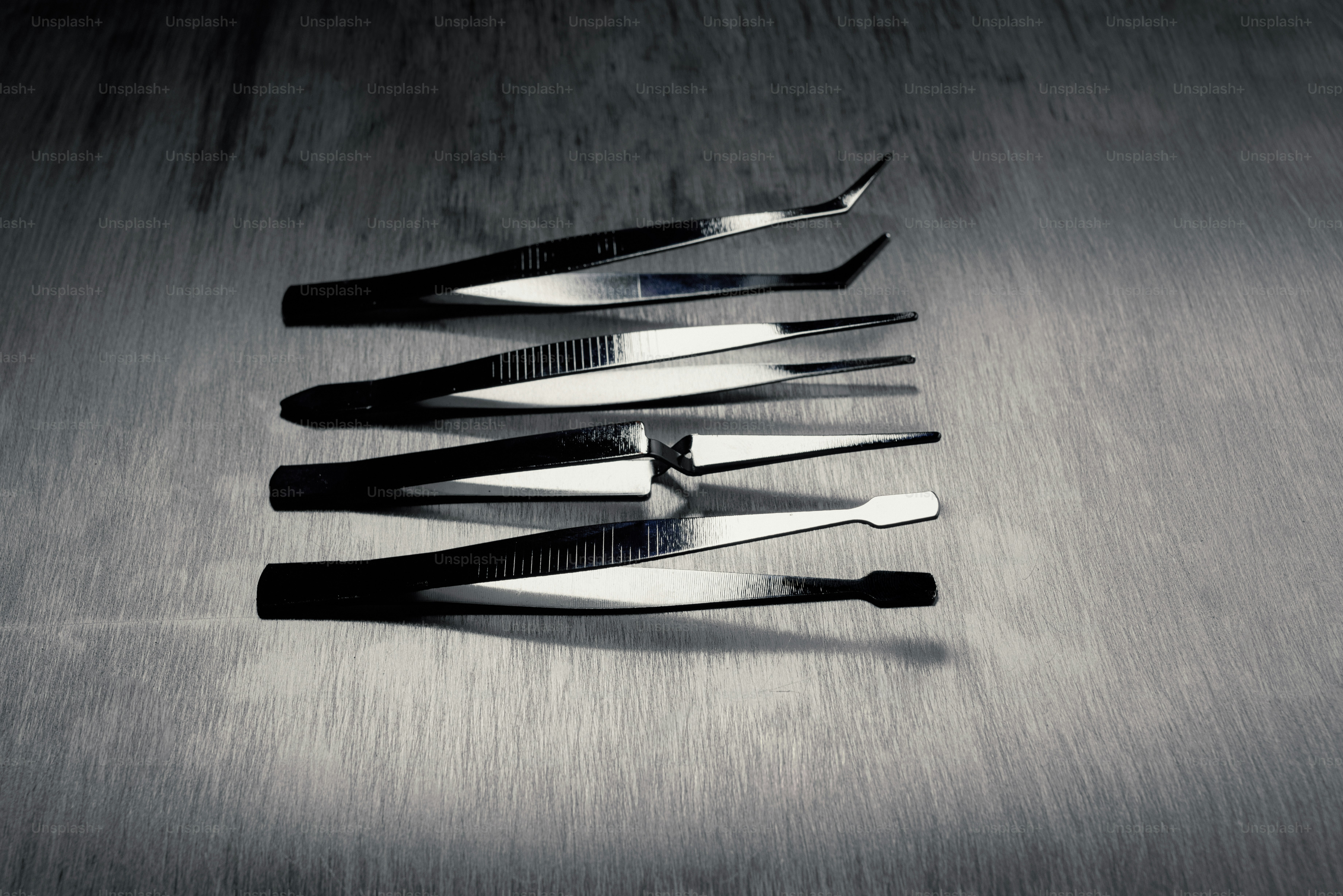 Four different types of tweezers arranged neatly photo – Texture Image ...