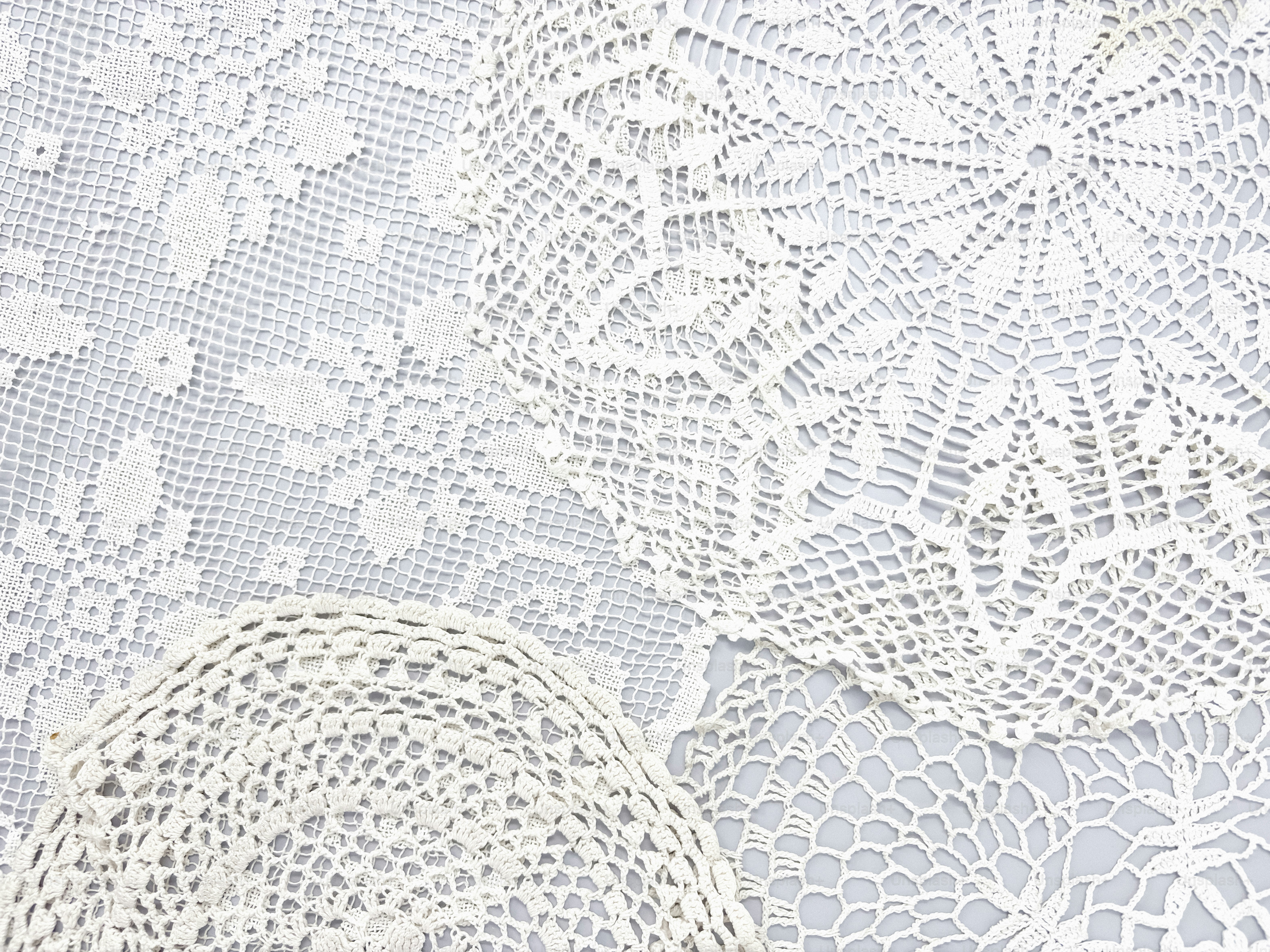 Close-up of delicate white lace doilies on a light background photo ...