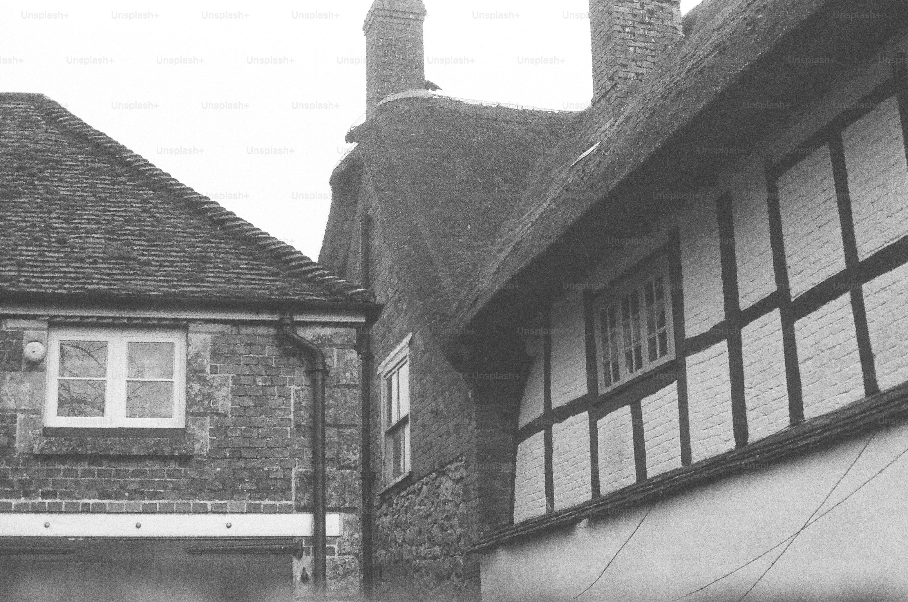 Tudor style building with thatched roof and chimney. photo – Texture ...