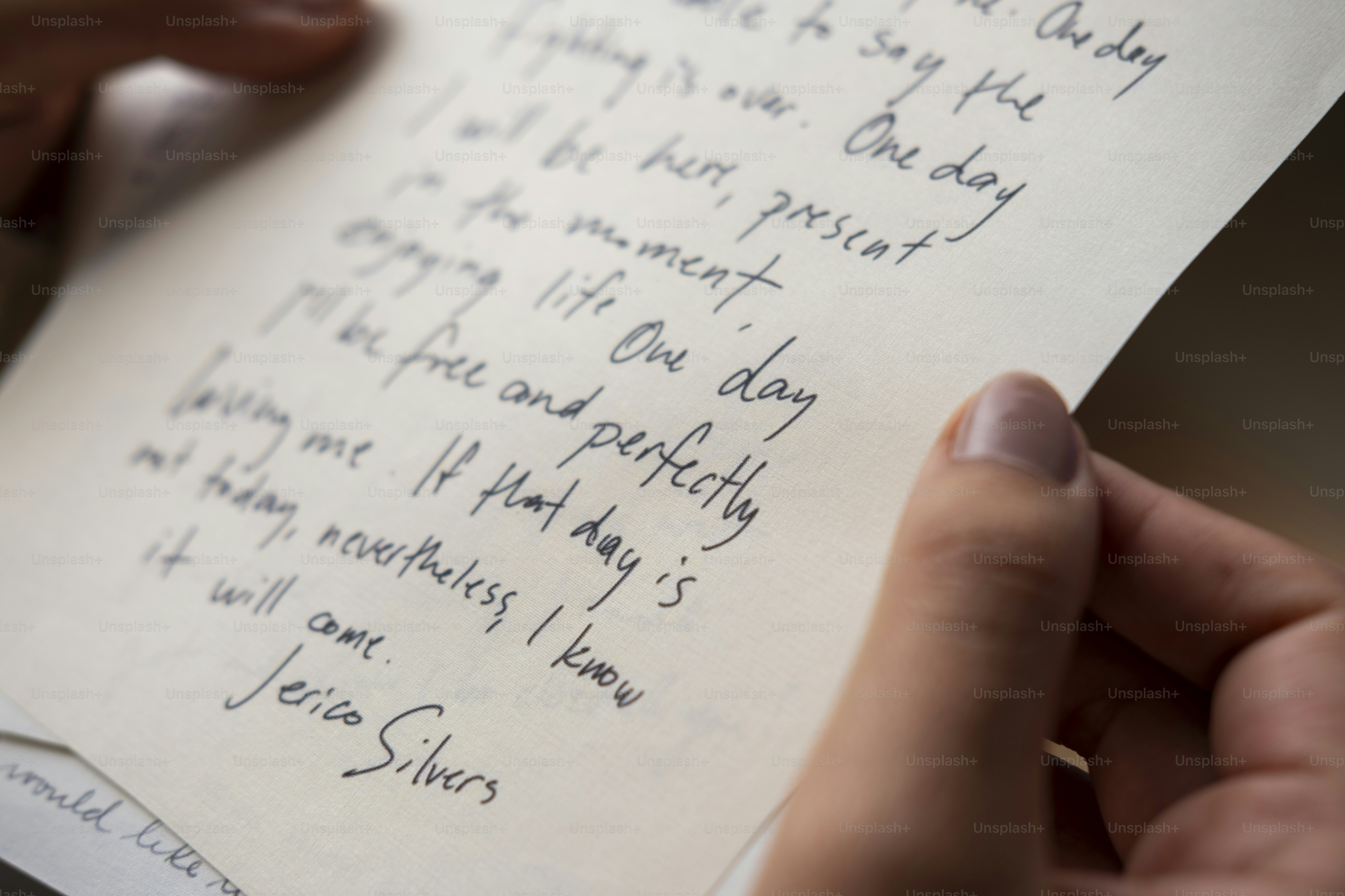 Hands holding a handwritten letter with a signature. photo – Paper ...