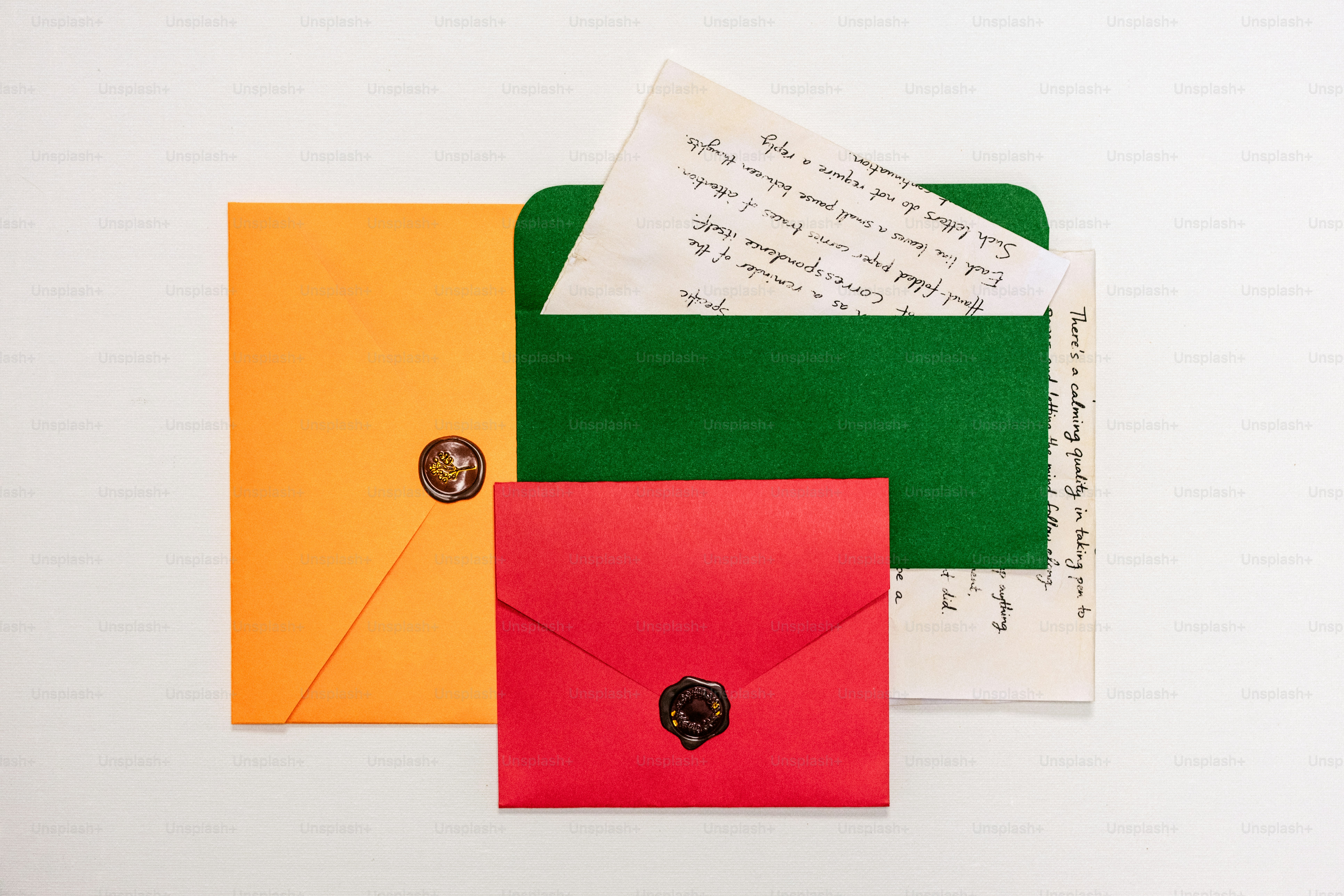 Three colorful envelopes with wax seals on white background photo ...