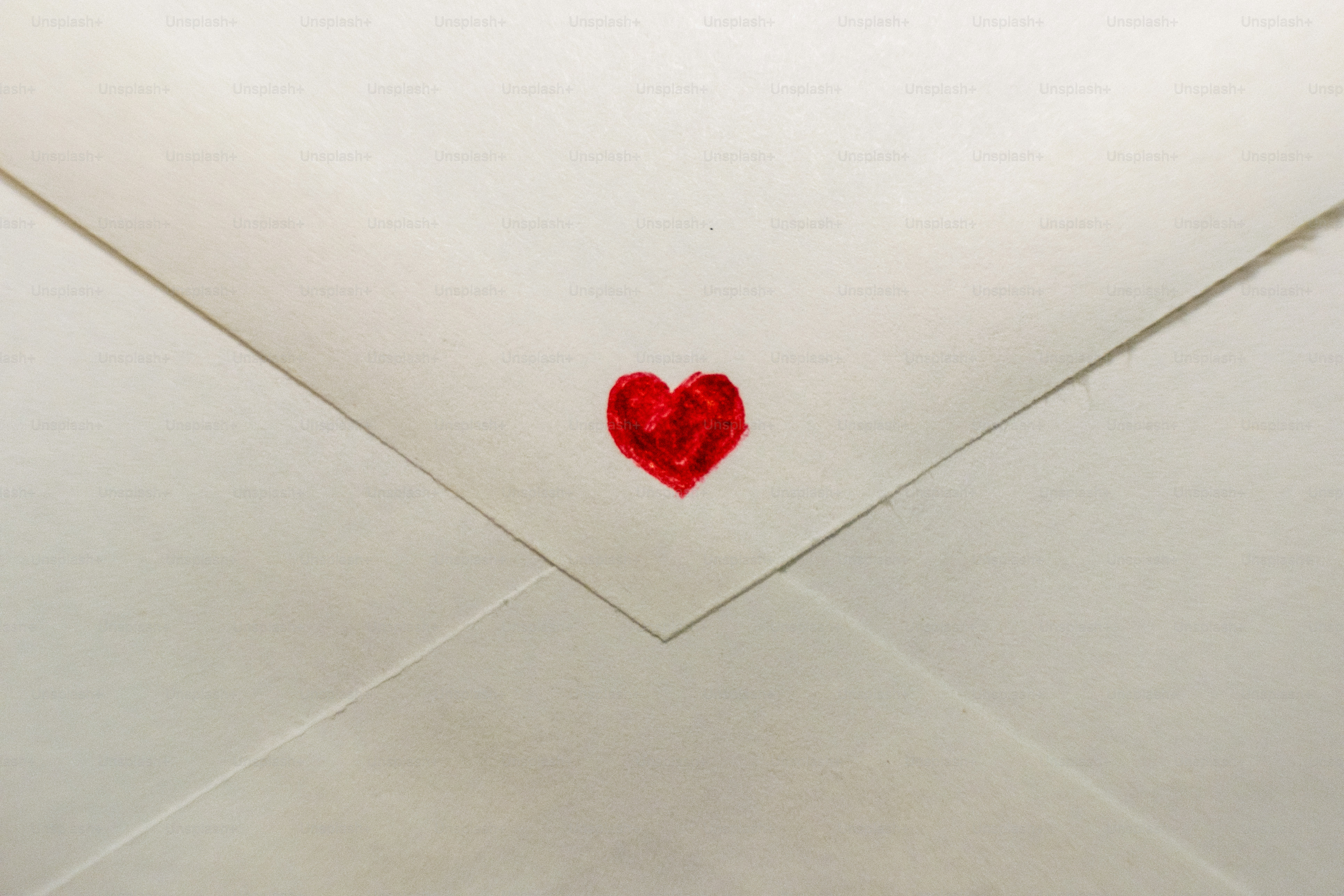 Brown envelope tied with a red ribbon on white background photo – Paper ...