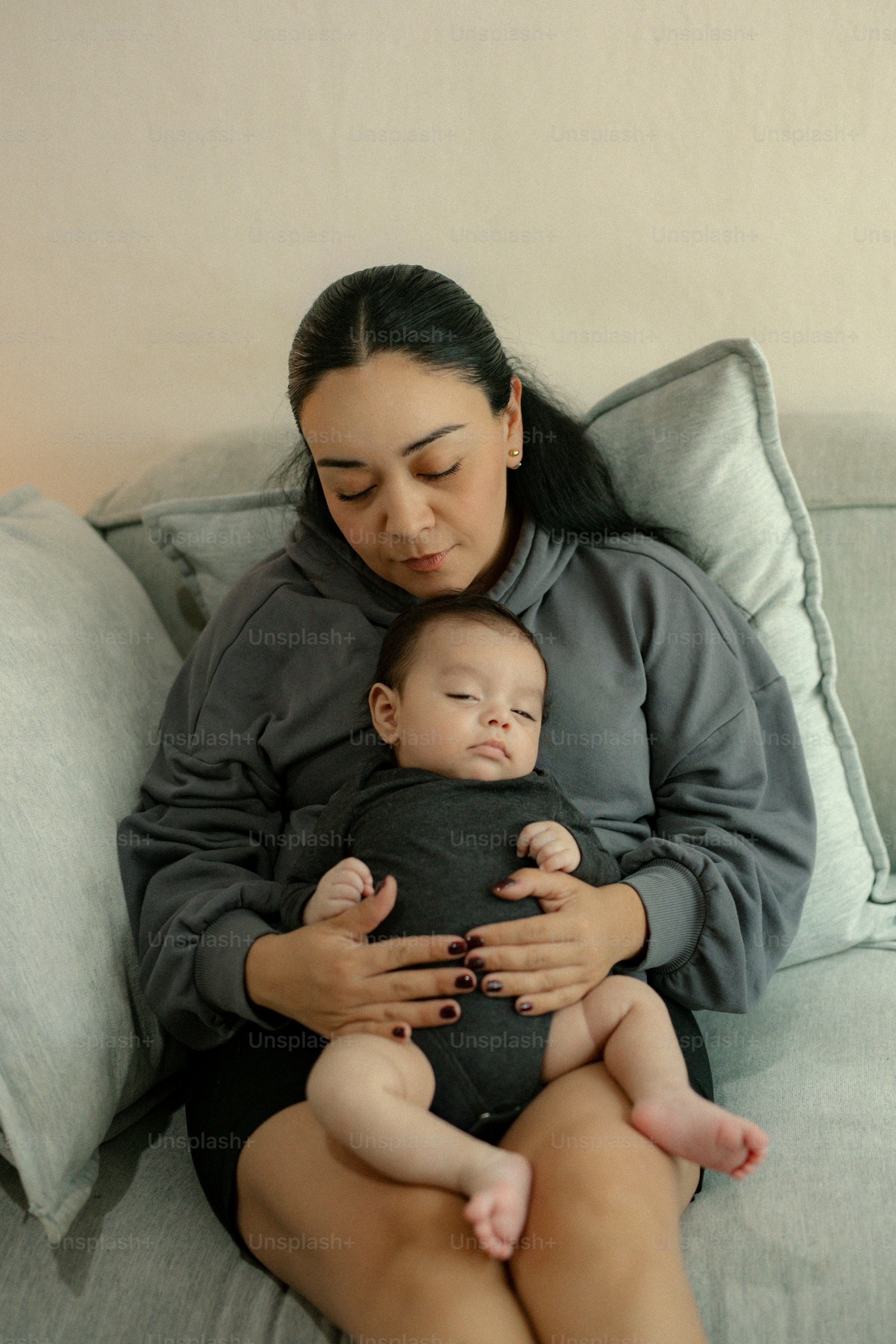 A person putting striped socks on a baby's foot photo – Family Image on ...