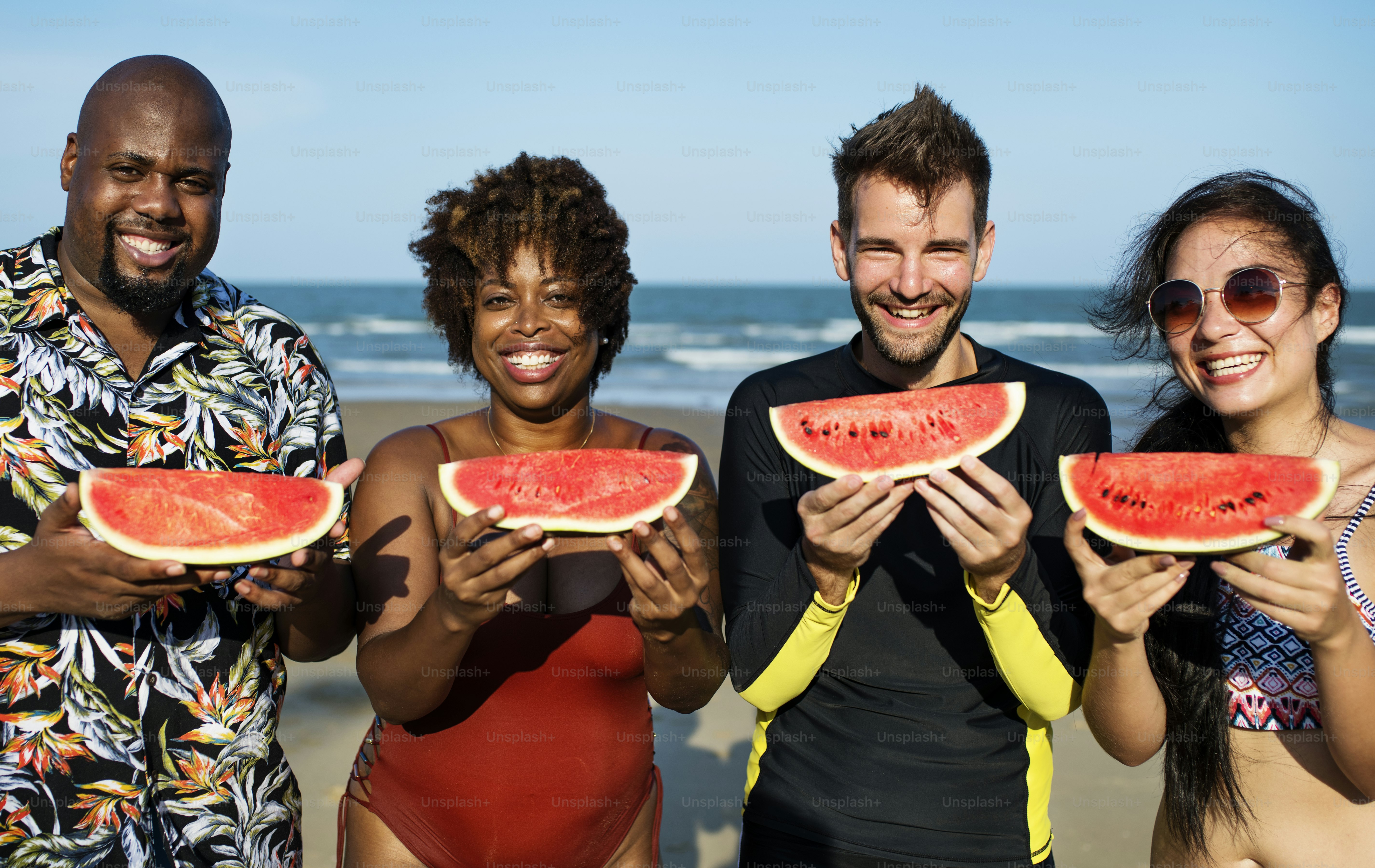Friends eating watermelon on the beach photo – Beach Image on Unsplash