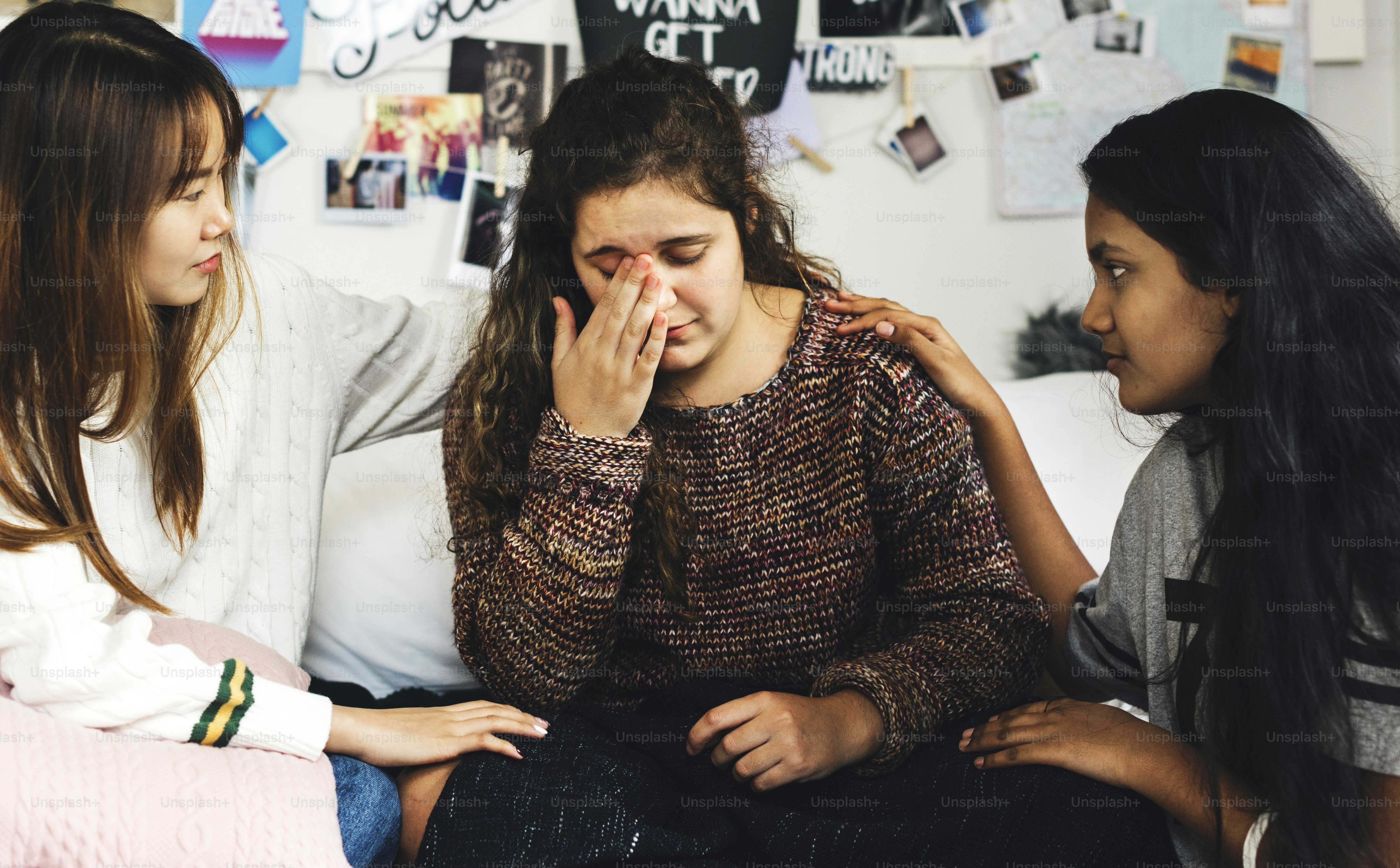 Teenage girls consoling their depressed crying troubled friend***These ...