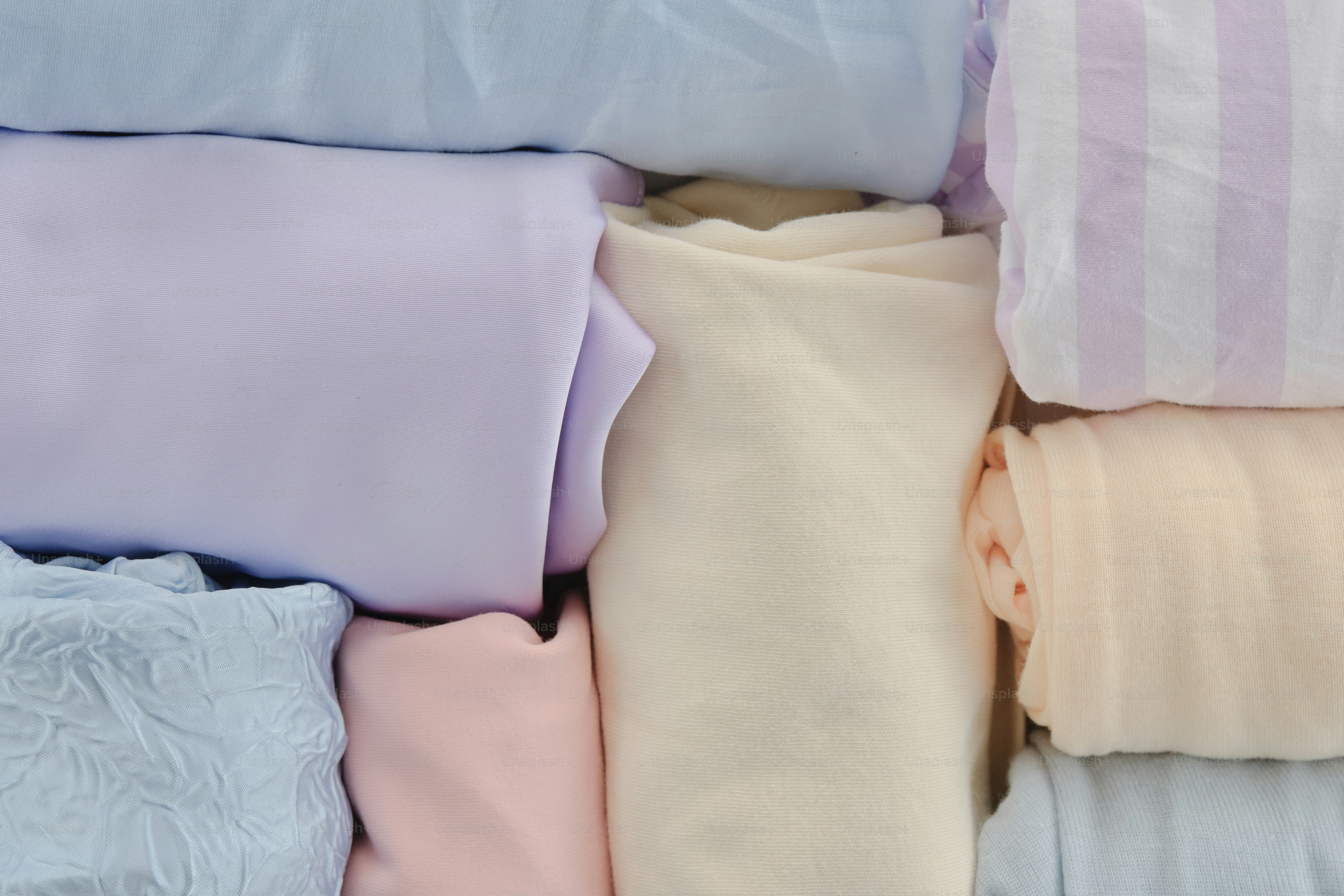 Soft pastel colored fabrics neatly folded together photo – Wallpaper ...