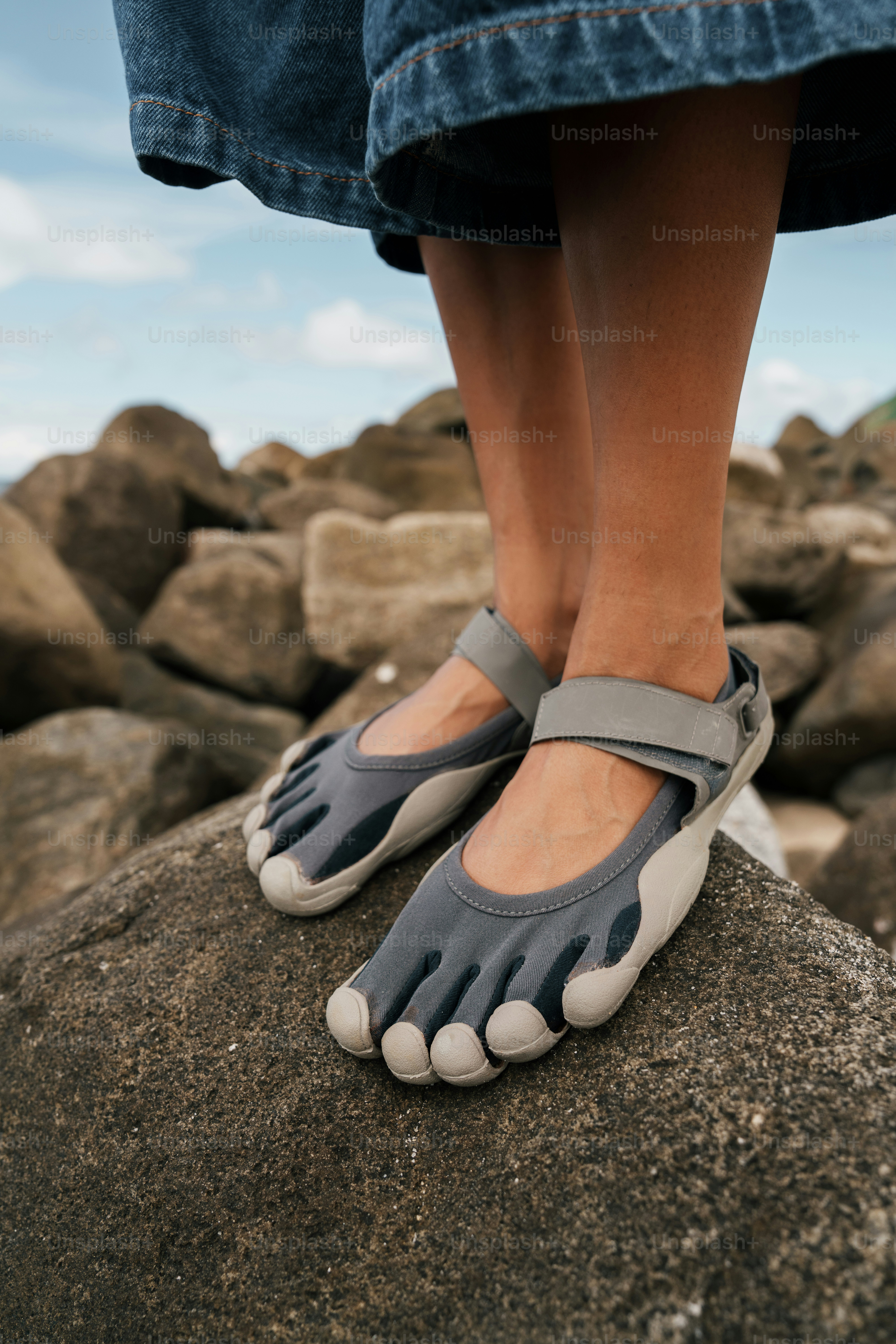 Person wearing minimalist toe shoes on rocks photo – Active lifestyle ...