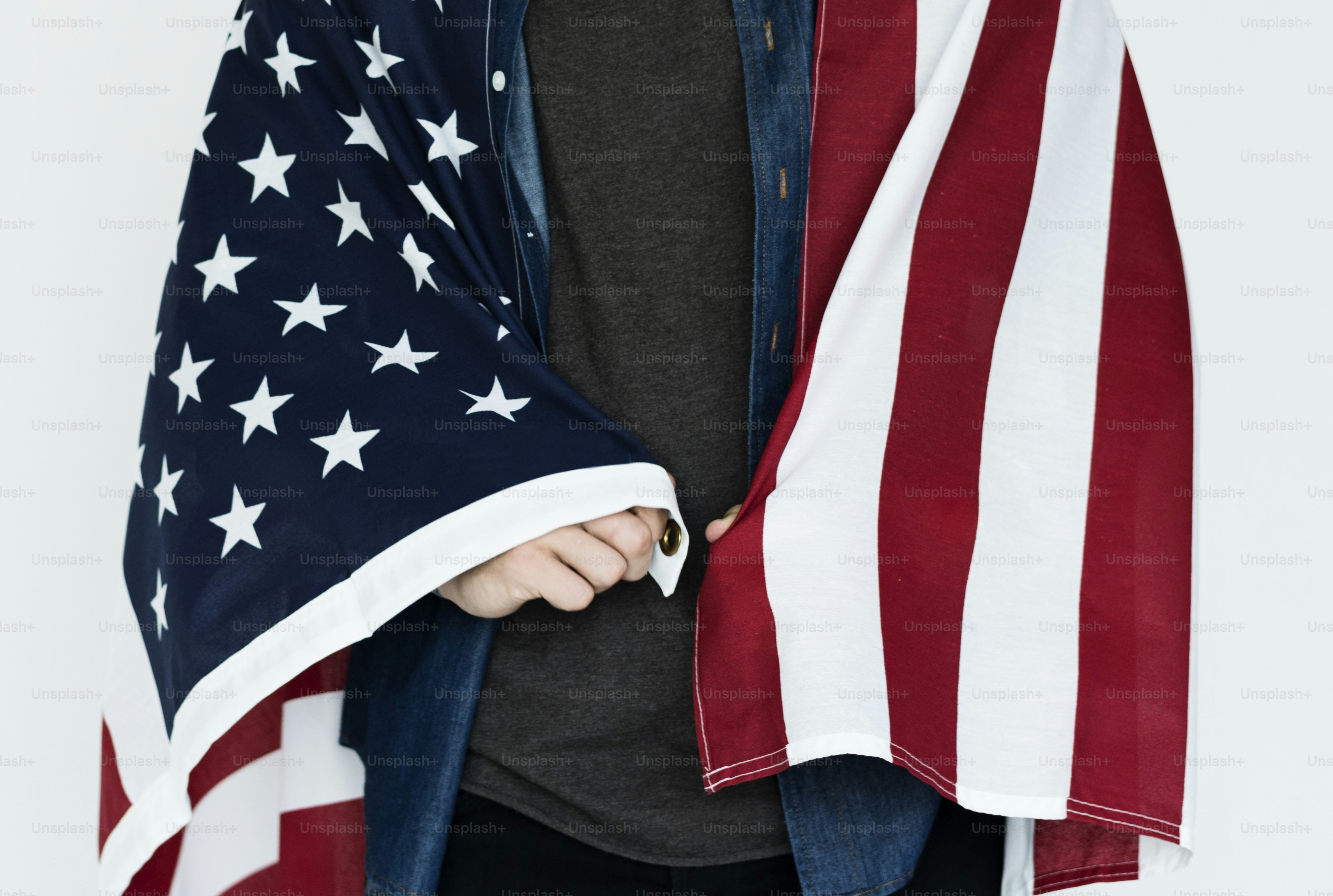 Person standing and holding country flag around the shoulder photo ...