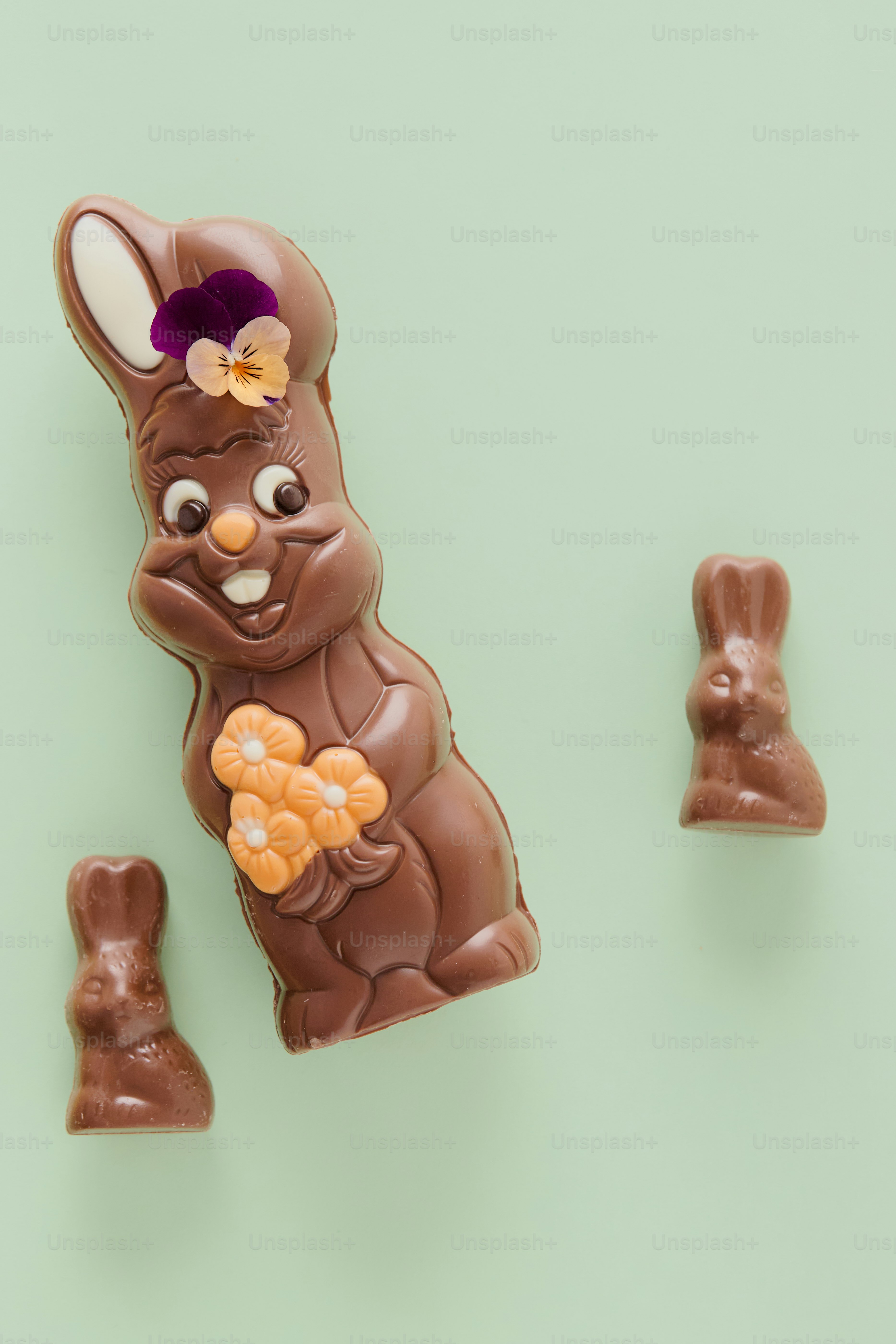 Chocolate bunnies and eggs scattered on a yellow background photo ...