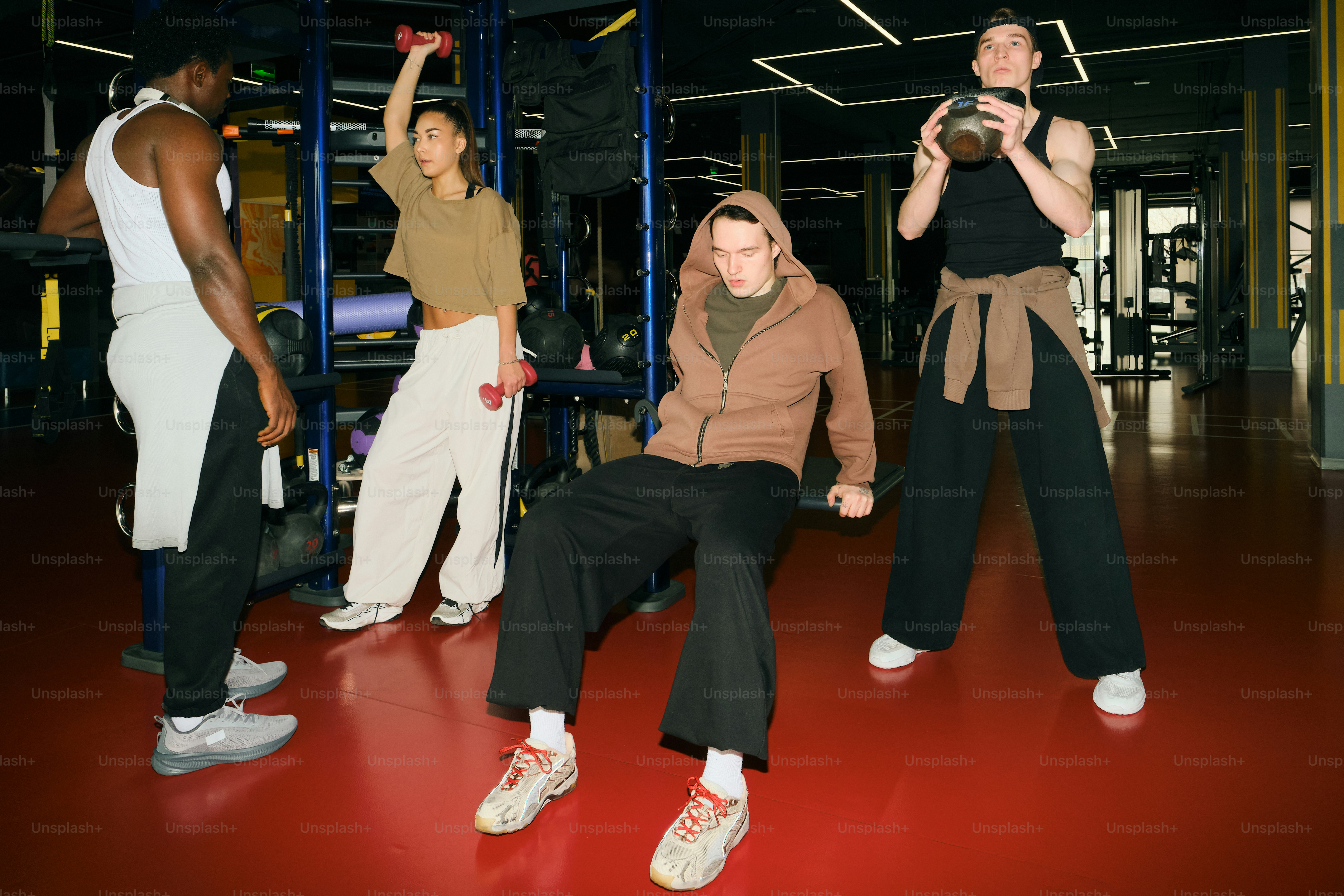 Four people exercising in a gym photo – Gym Image on Unsplash