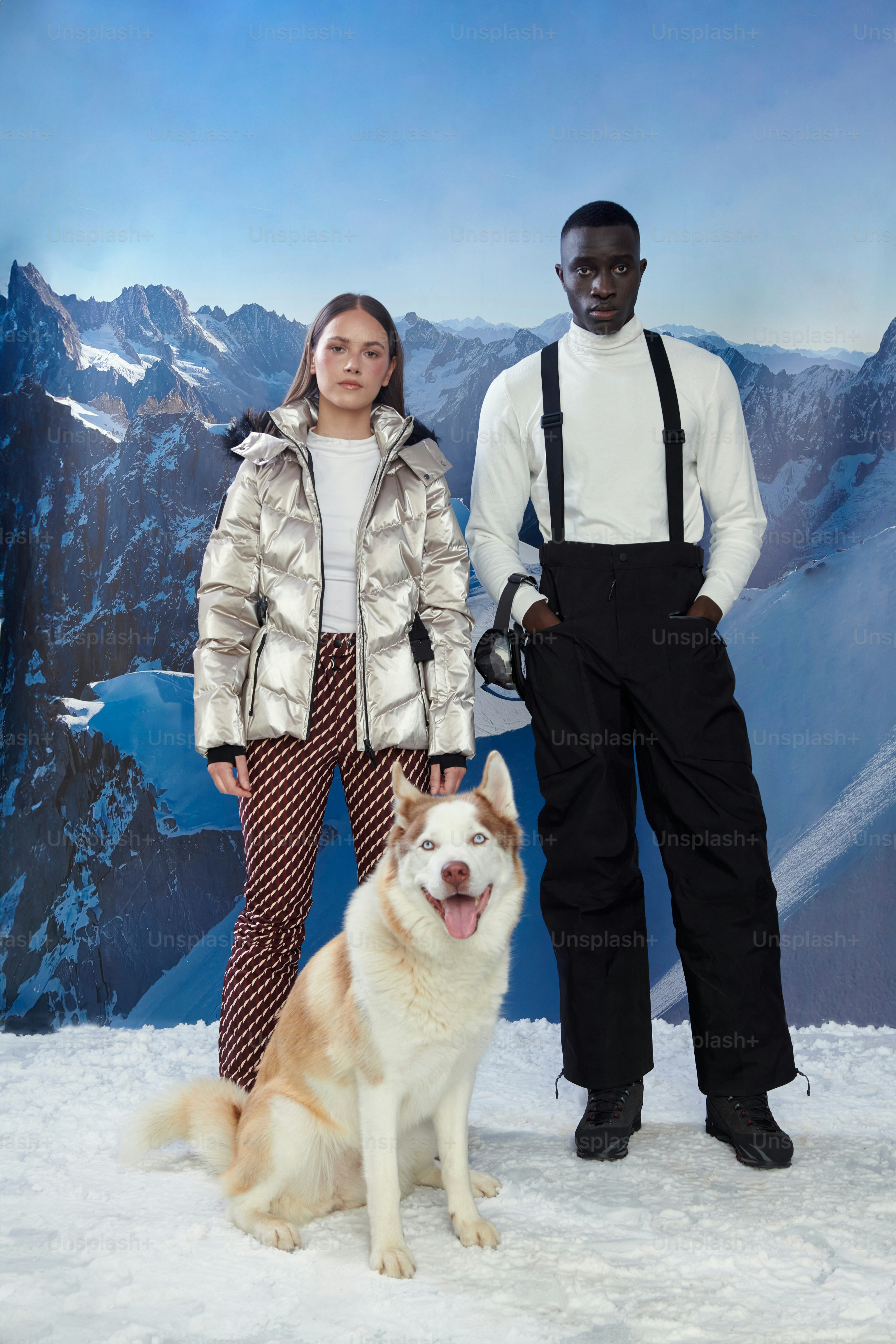 A man, woman, and husky pose in snow. photo – Fashion model Image on ...