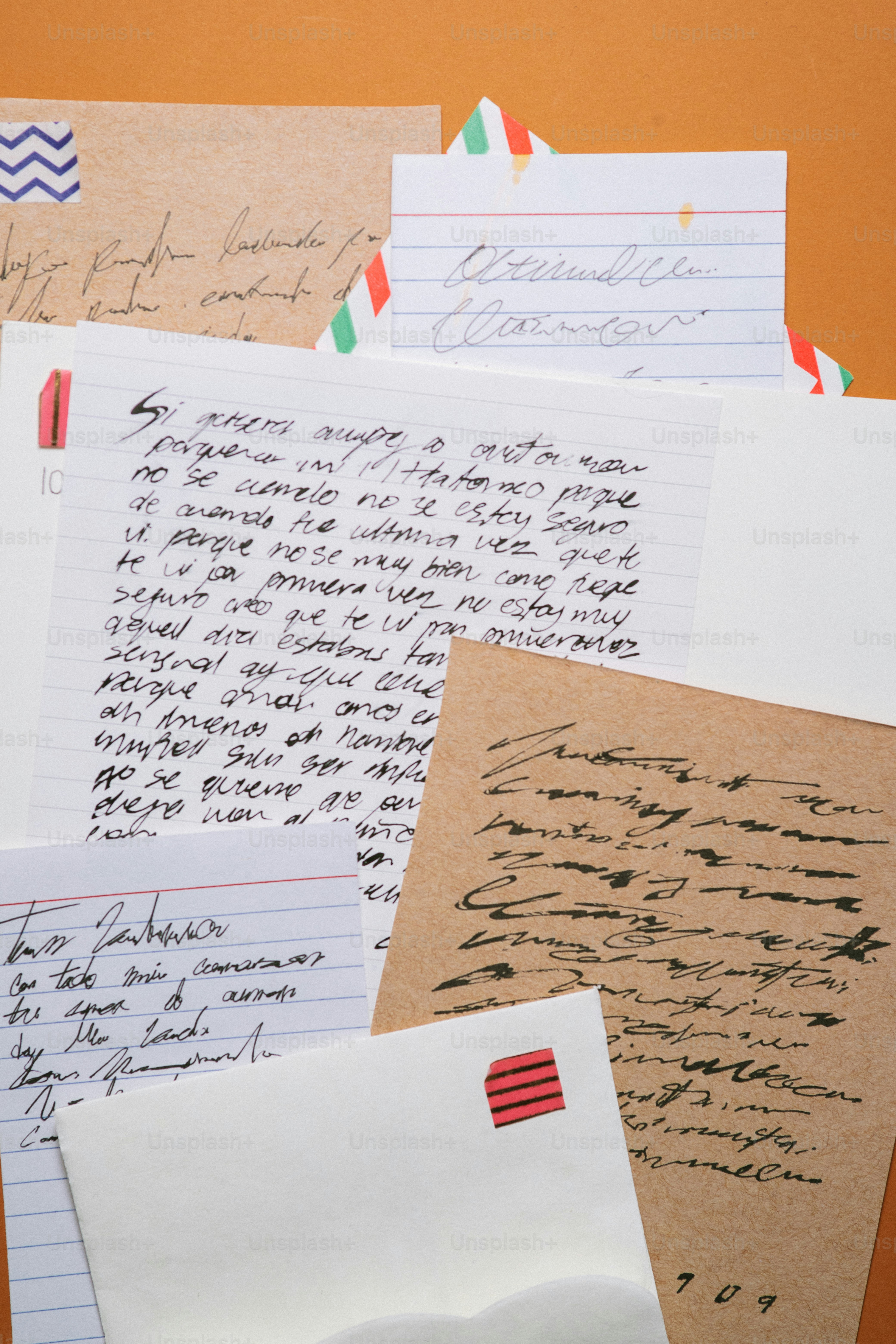 Handwritten notes in envelopes on red background. photo – Paper Image ...