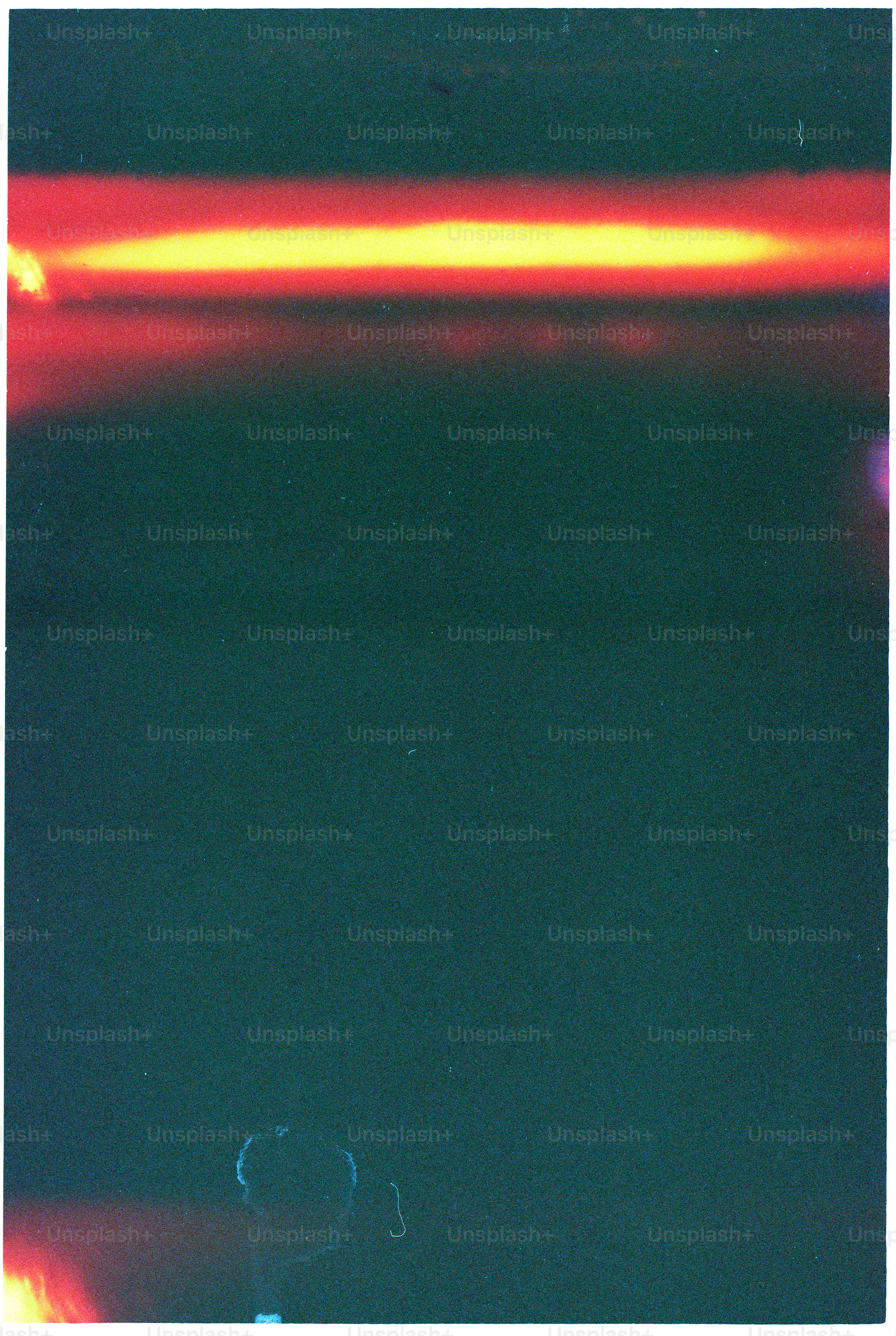 Abstract streaks of red and yellow light on dark background photo ...