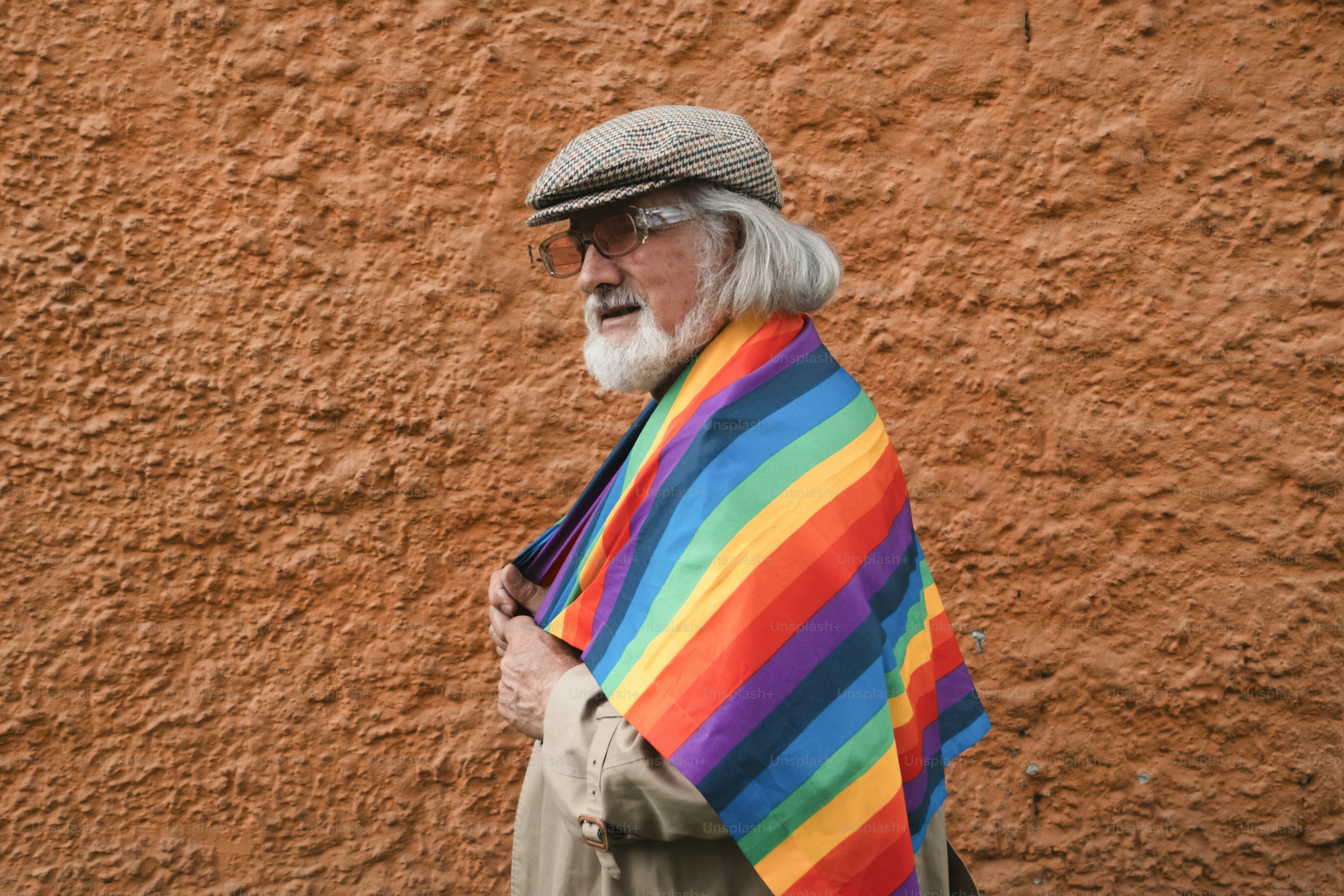Elderly man with rainbow flag face paint smiles joyfully photo ...